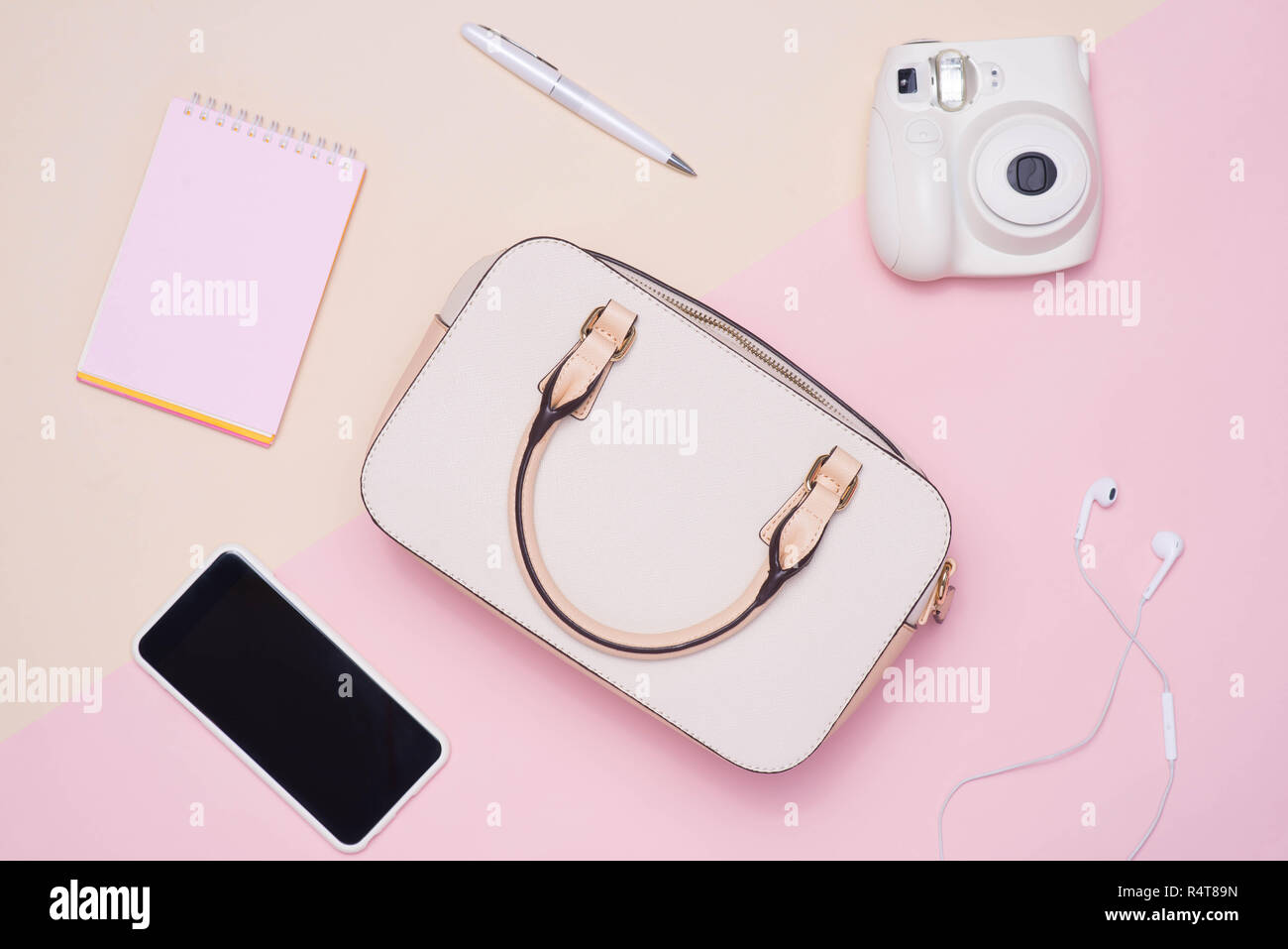 Flat lay of female fashion accessories and white handbag on pastel ...