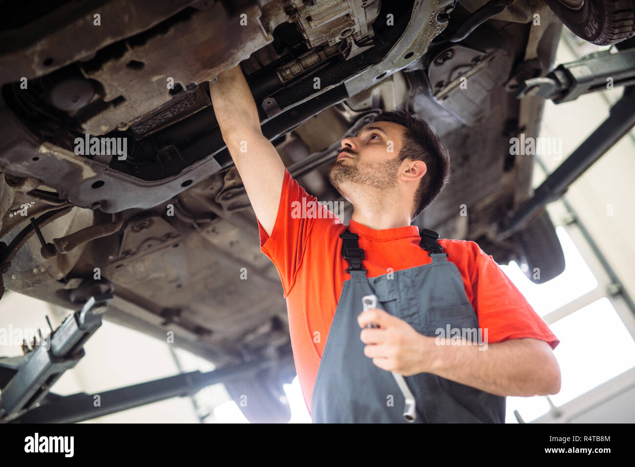 Car mechanic working at automotive service center Stock Photo - Alamy