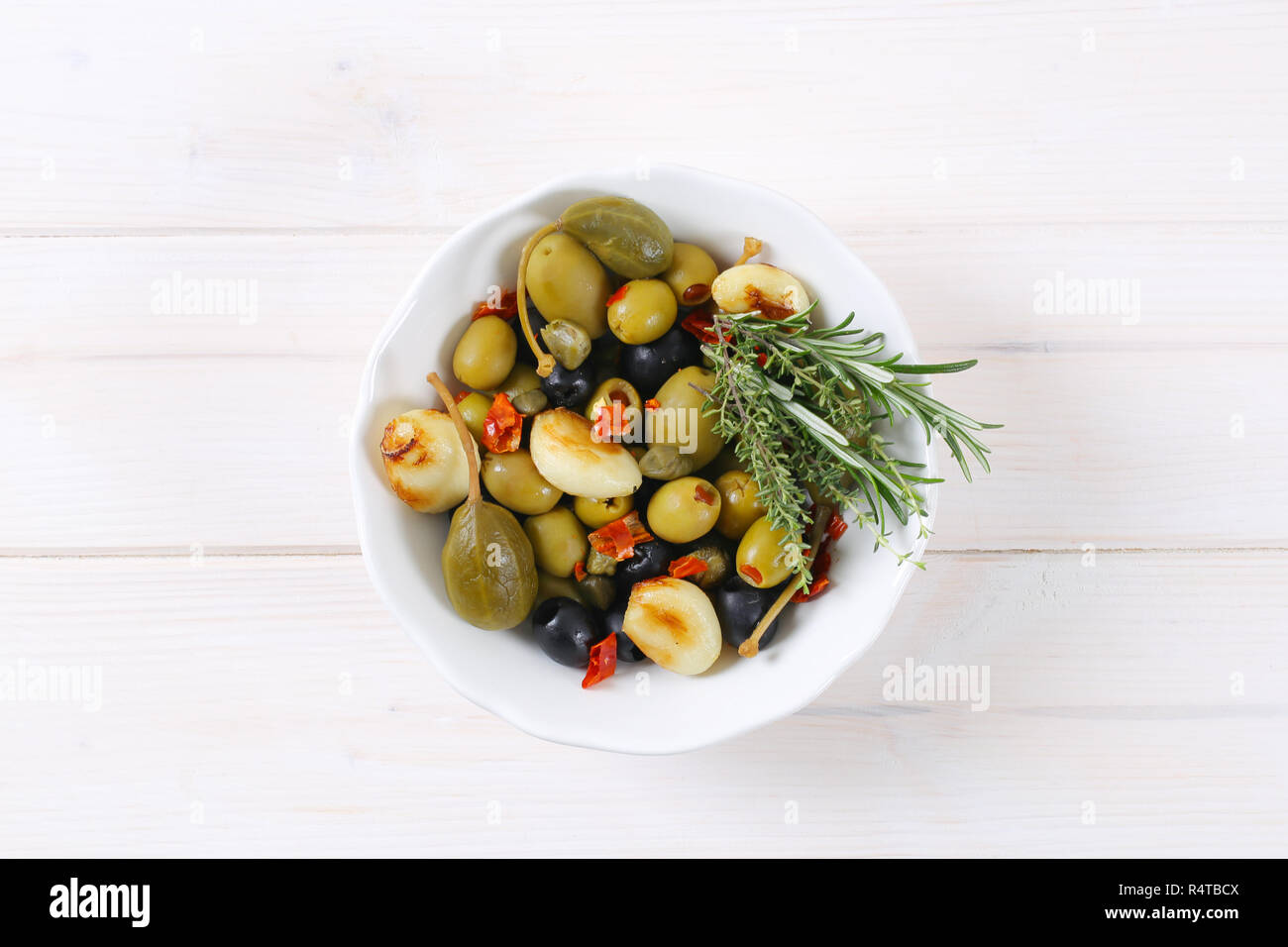 pickled olives, capers, caper berries and garlic Stock Photo - Alamy