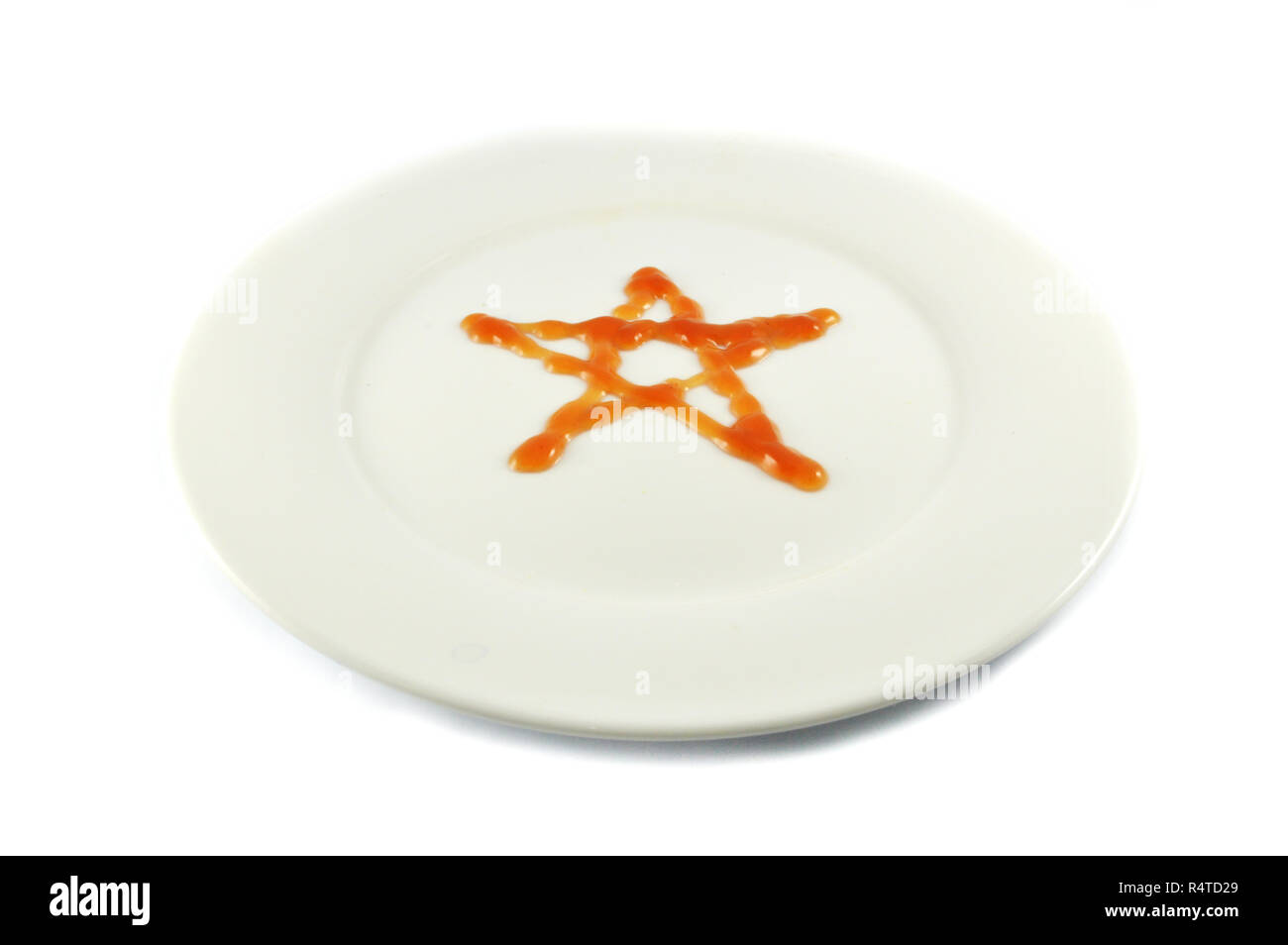 ketchup chilli sauce of star shape on plate isolated white background ...