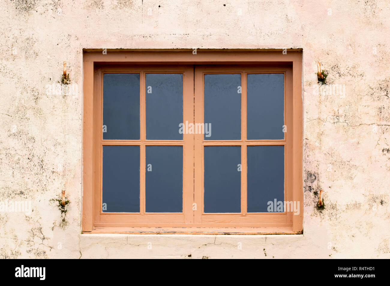 Wood framed windows on plaster wall Stock Photo - Alamy