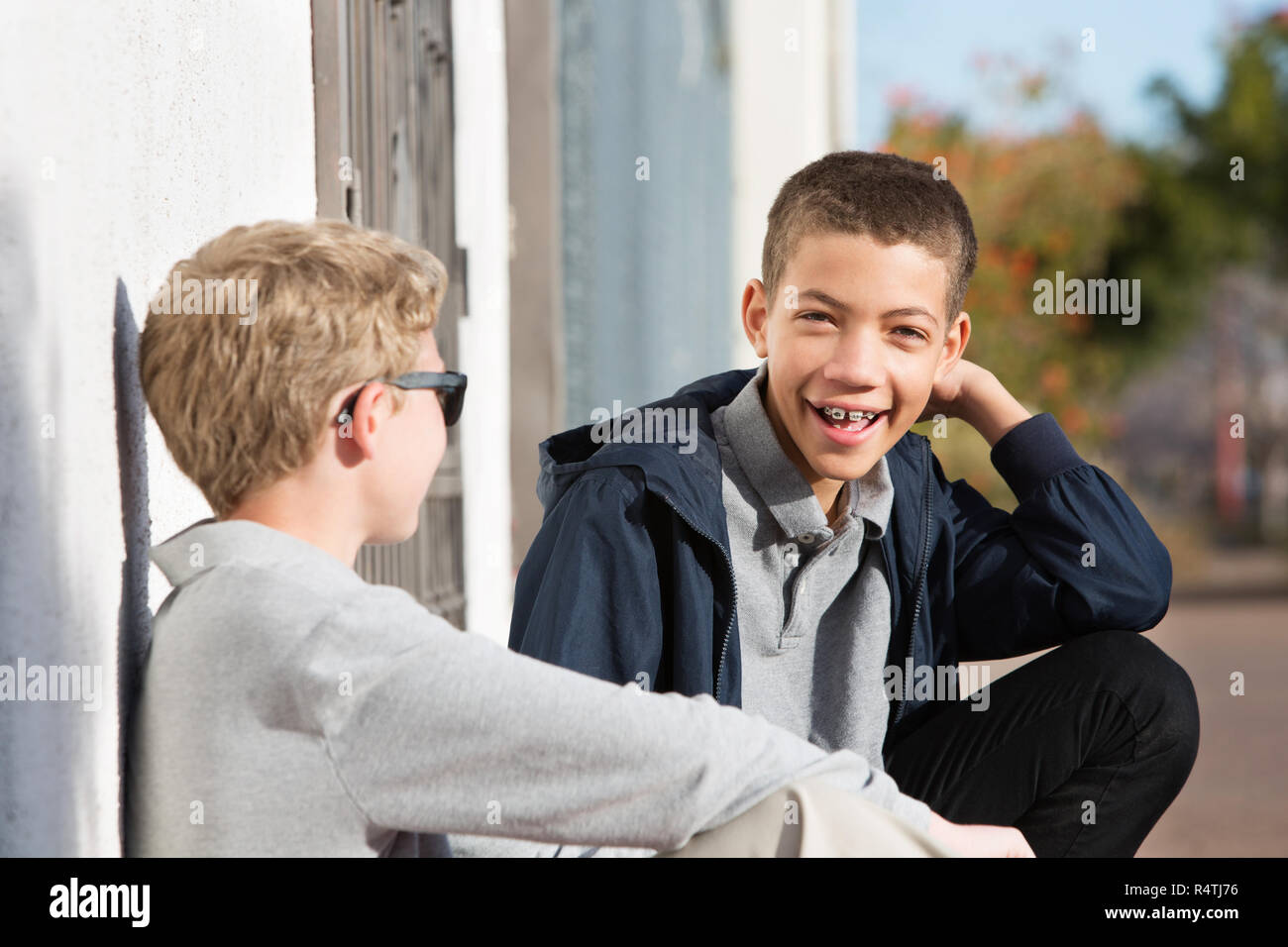Laughing teen with braces outside with friend Stock Photo - Alamy