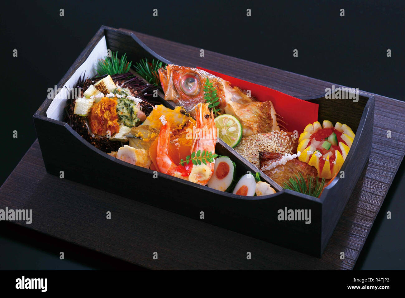 Bento of seafood in Japanese style with shrimp fish lemon egg and rice ...