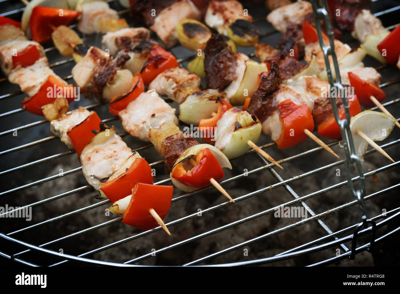 shashlik skewers with meat, peppers and onions on a barbecue grill ...