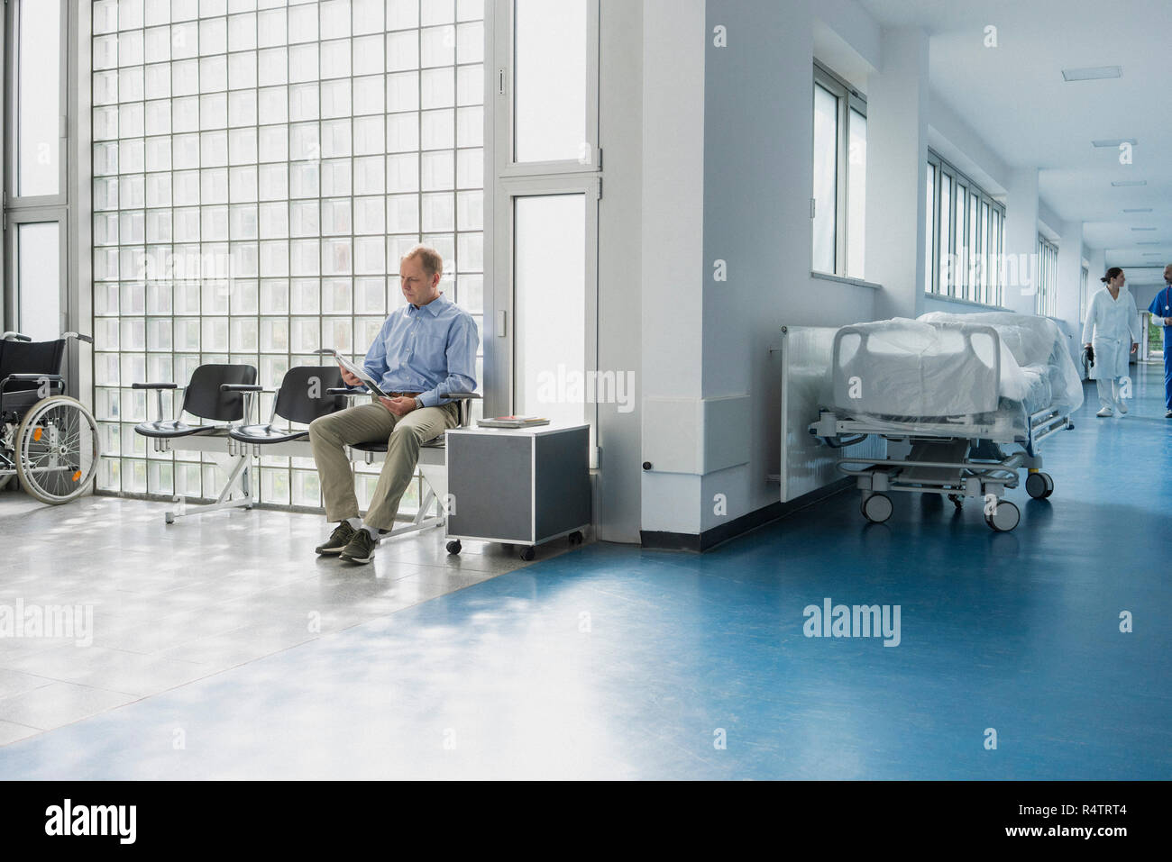 Male patient reading magazine, waiting in hospital waiting room Stock ...