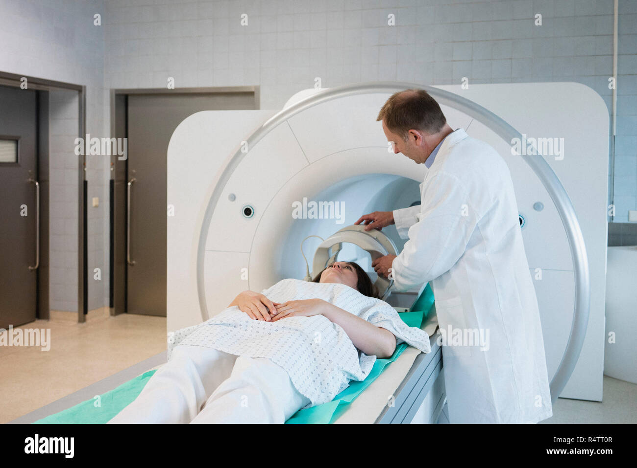 Doctor preparing patient for MRI in hospital Stock Photo - Alamy