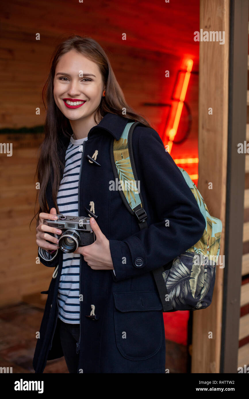 Happy young hipster woman holds retro photo camera. Having fun in the ...