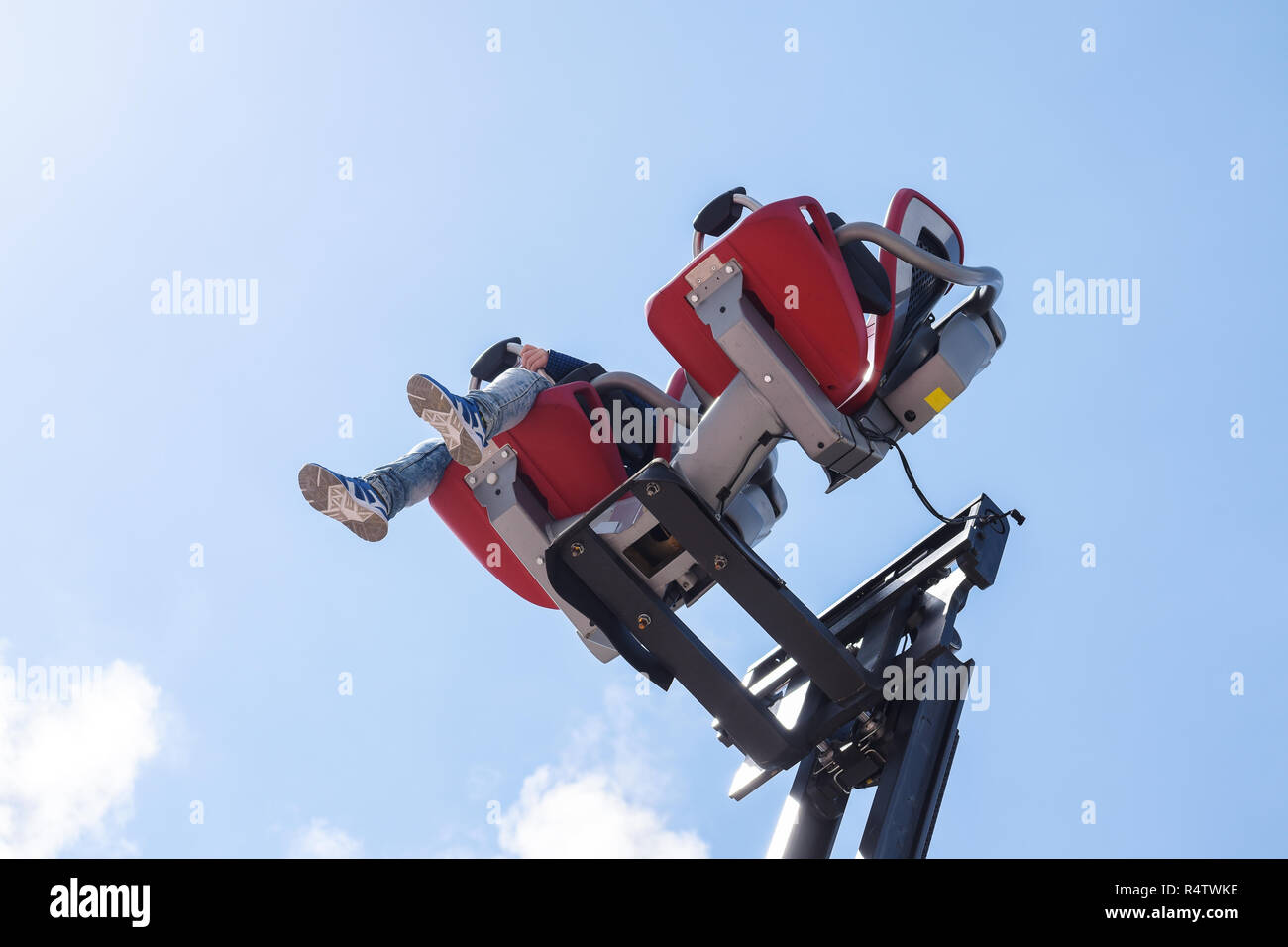 child sits on carousel seats mounted on a forklift and drives upwards ...