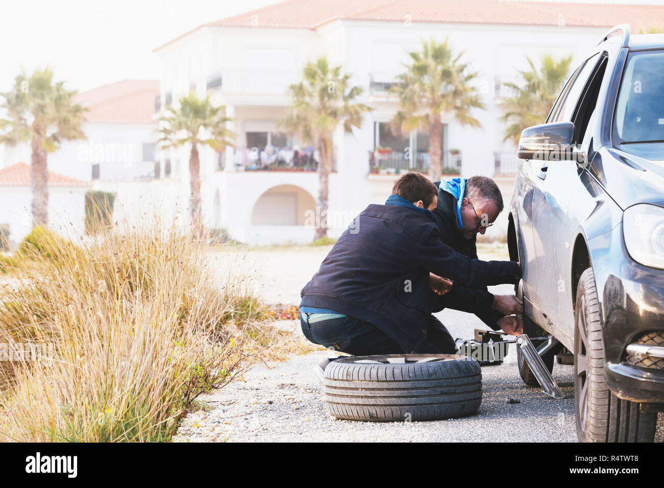 Changing tire helping child hi-res stock photography and images - Alamy