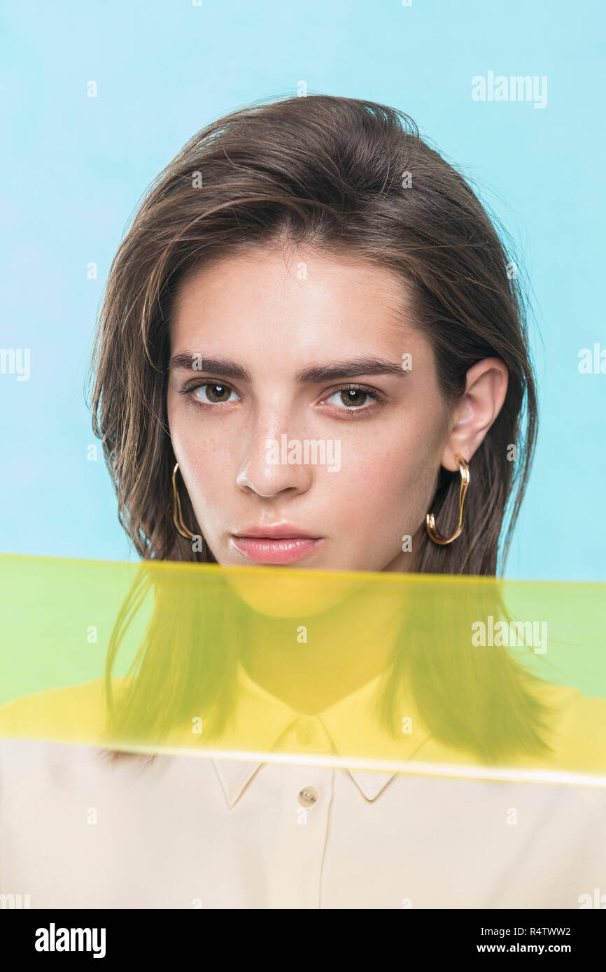 Portrait of a female fashion model against blue background Stock Photo ...