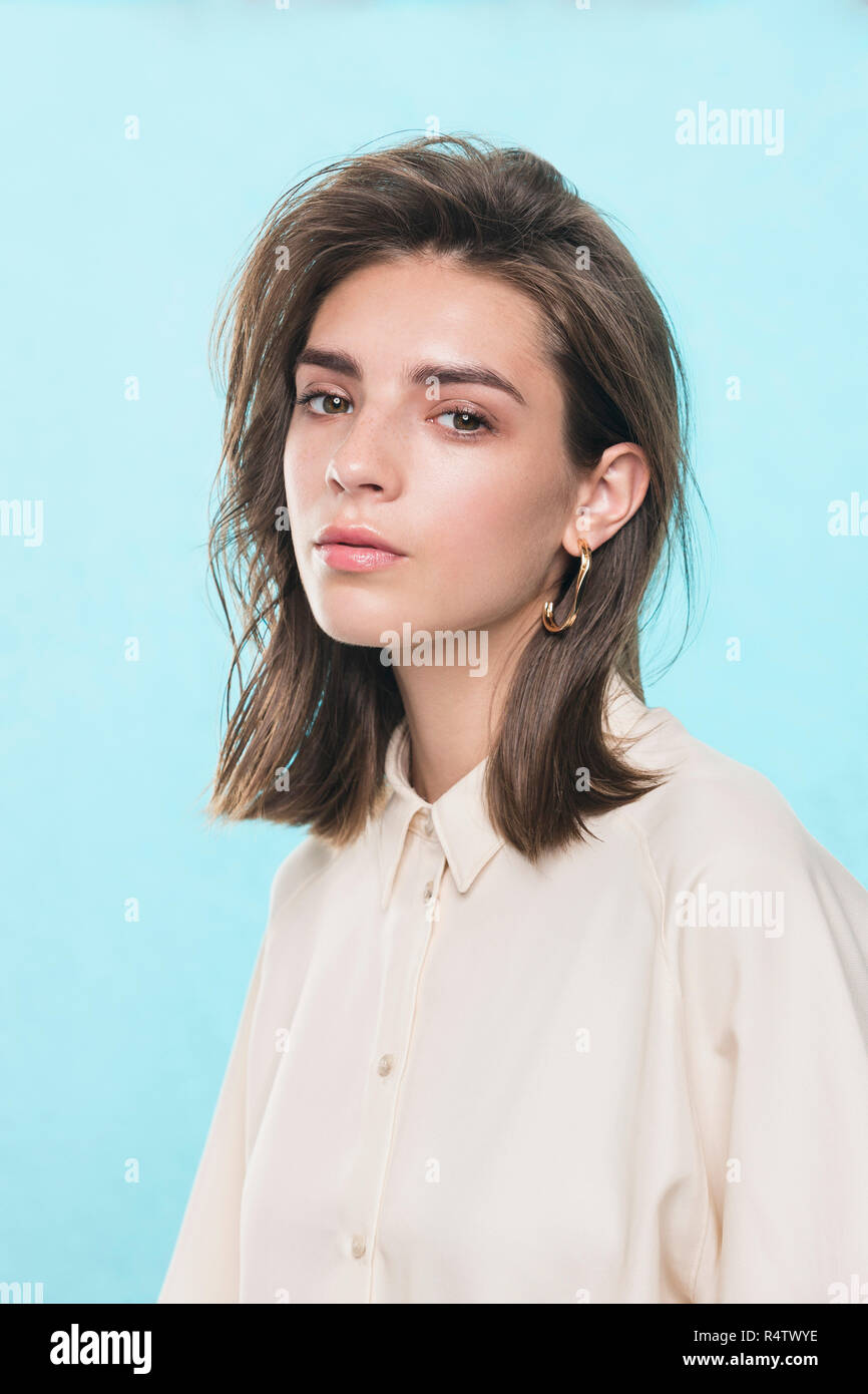 Portrait of female fashion model against blue background Stock Photo ...