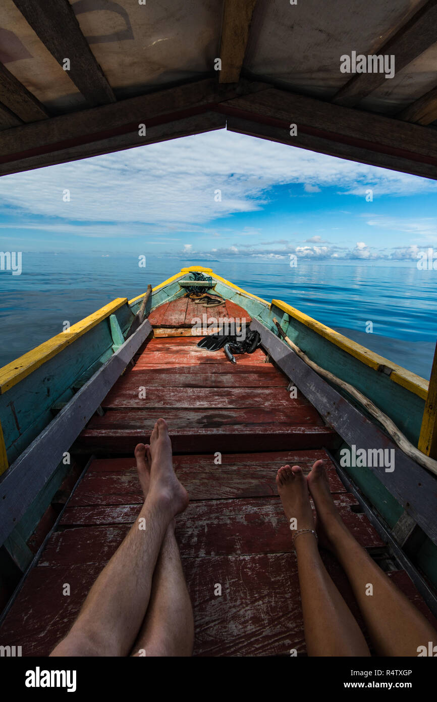 A couple is enjoying a boat ride in the Indonesian ocean Stock Photo ...