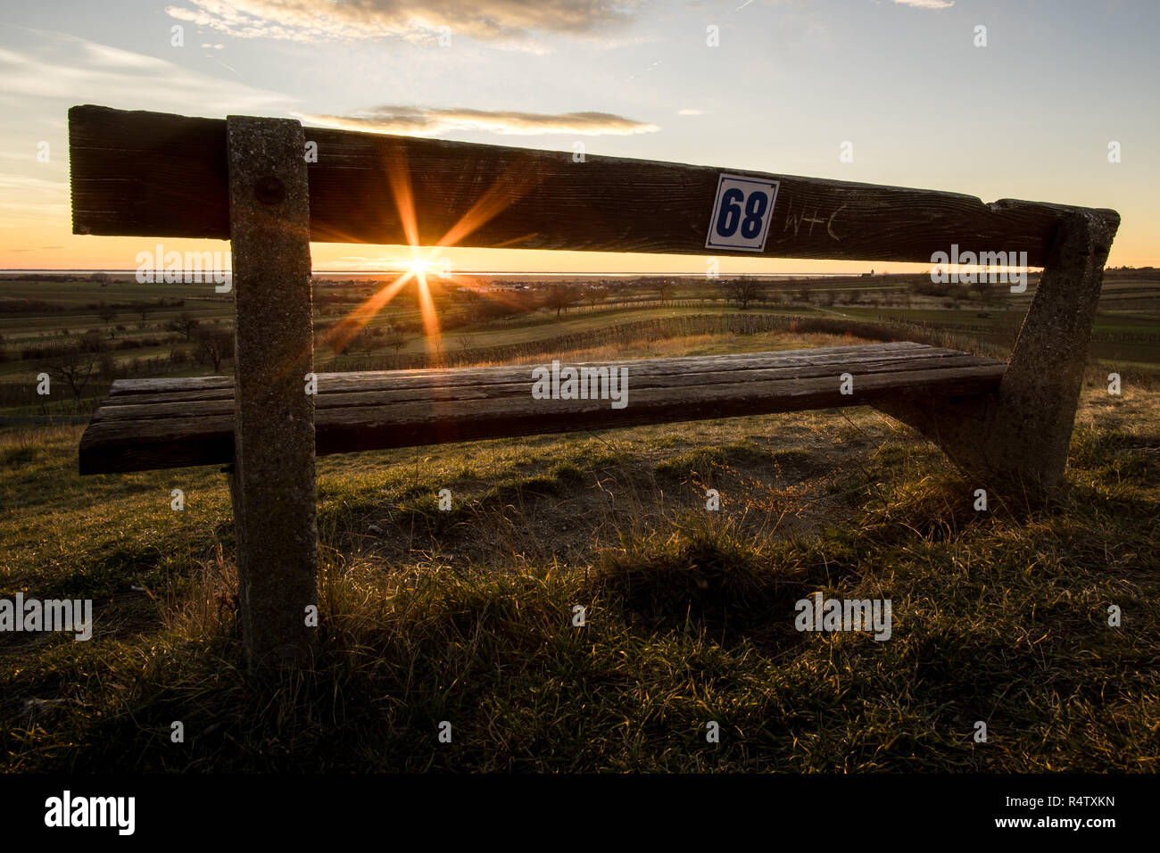 The first sunlight of the day brings warmth to this resting bench Stock ...