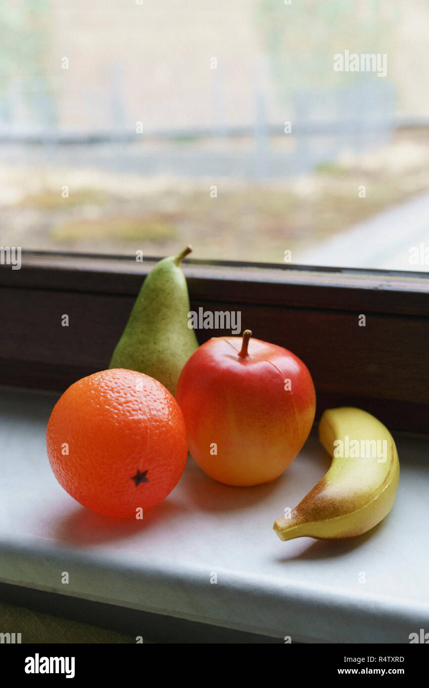 Plastic fruits on windowsill Stock Photo - Alamy