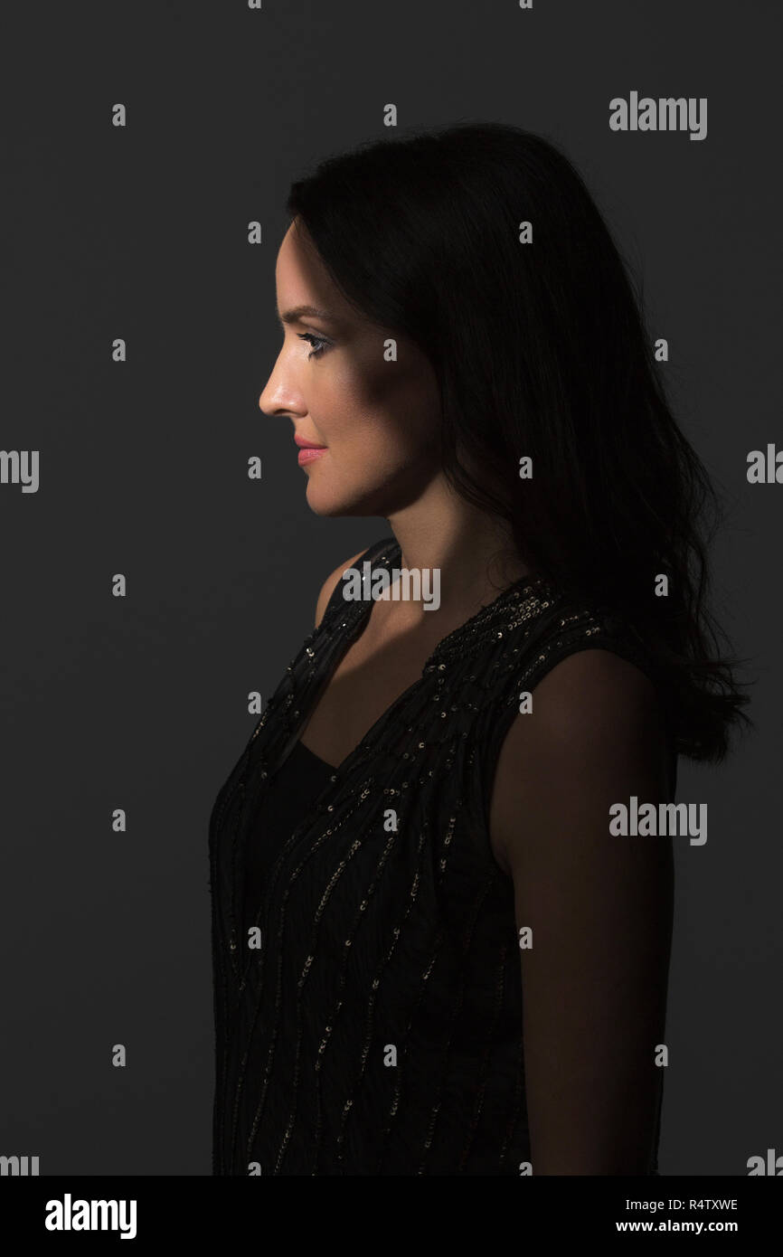 Portrait of beautiful woman in side profile and amidst shadow Stock ...