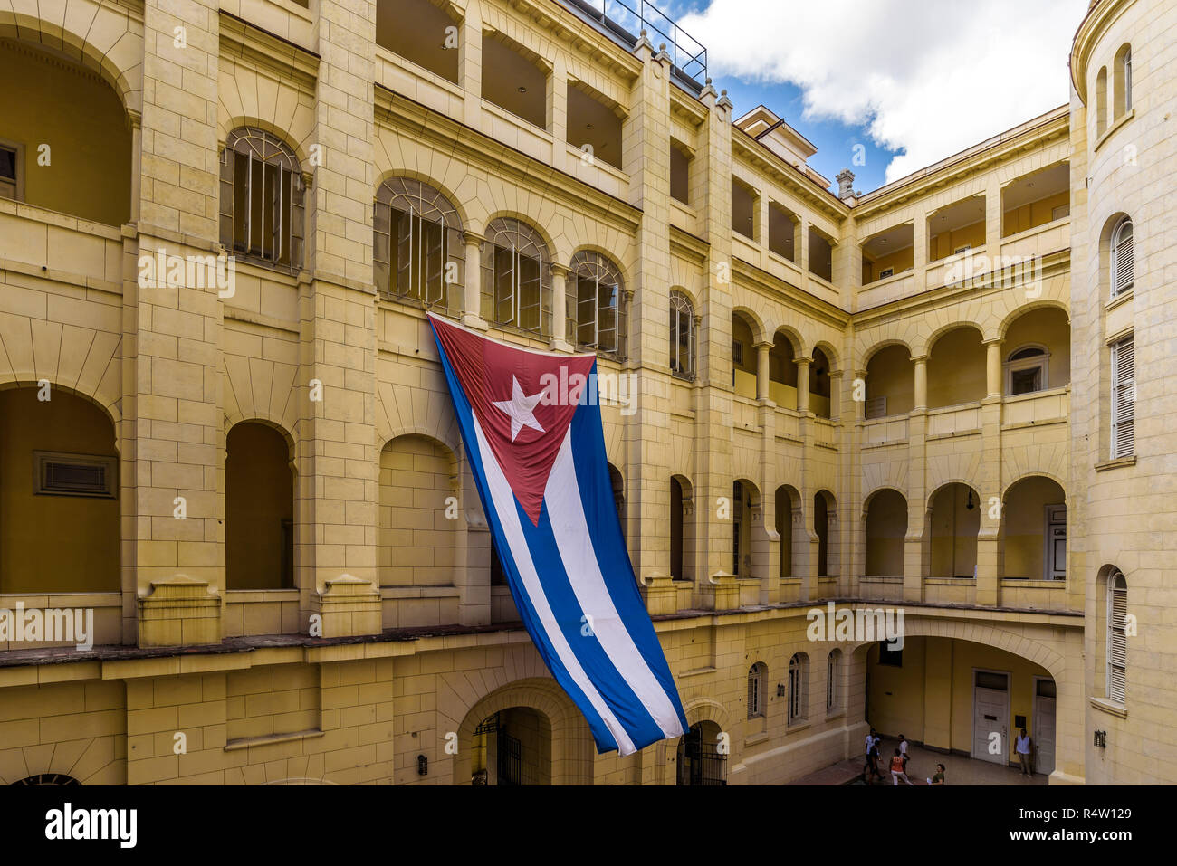 A very large Cuban national flag hangs inside the courtyard of the ...