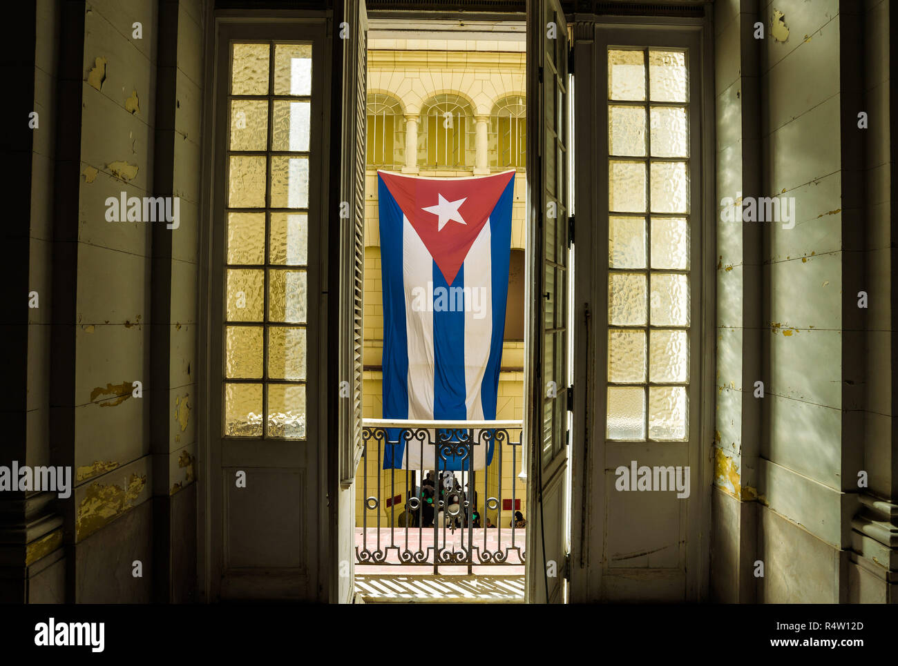 A very large Cuban national flag hangs inside the courtyard of the ...