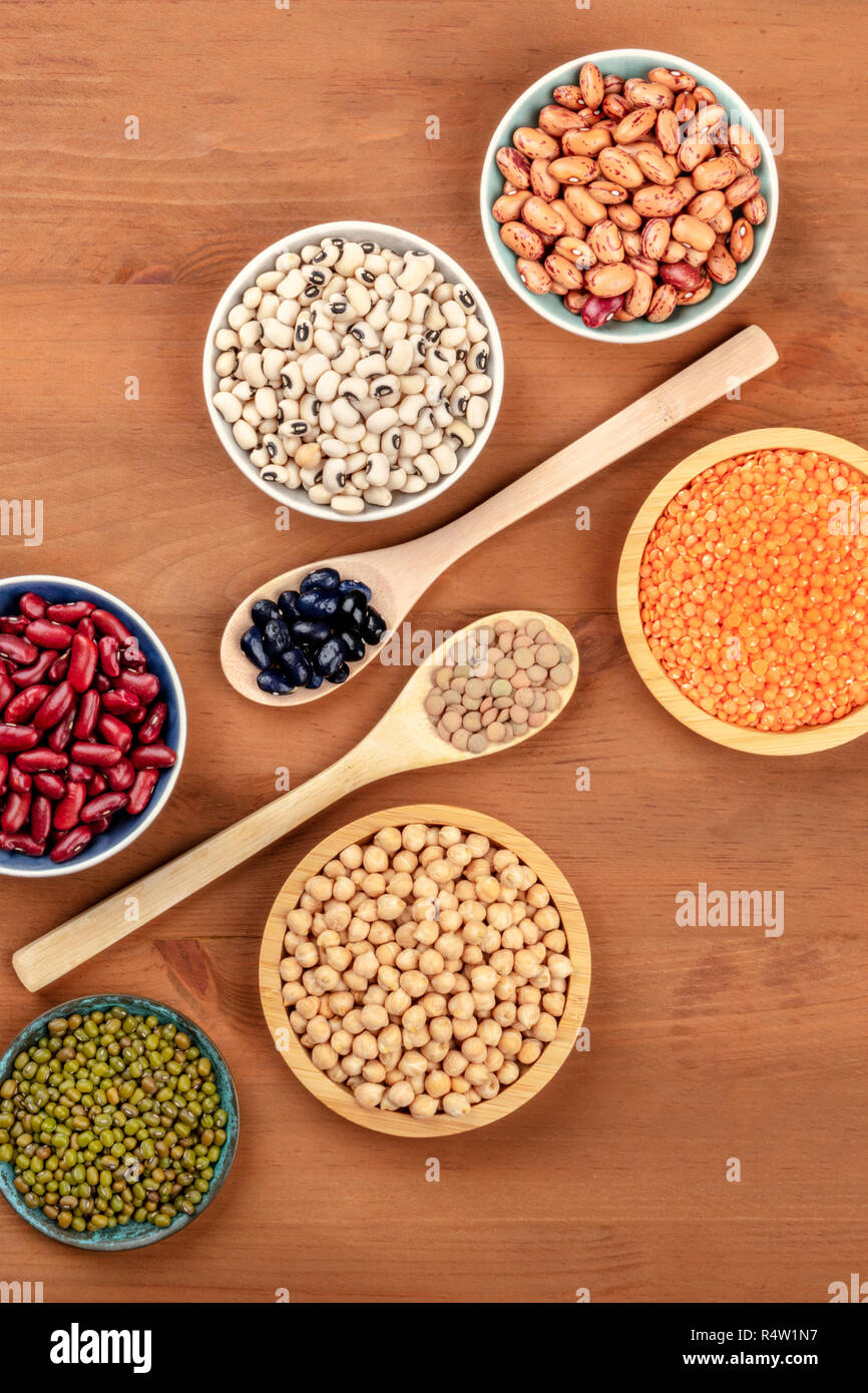 Various types of pulses, shot from above on a dark rustic wooden ...