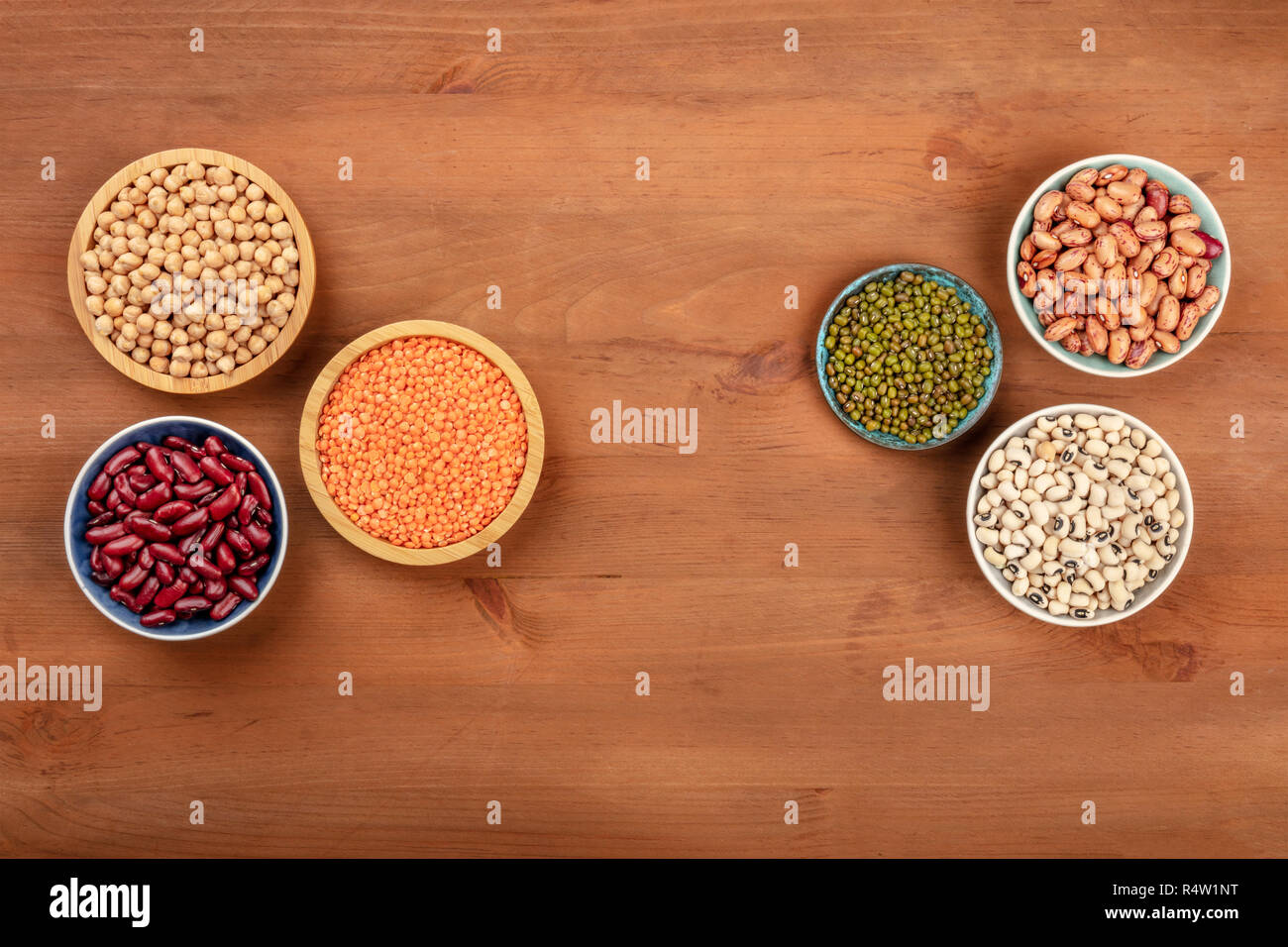 Various types of pulses, shot from above on a dark rustic wooden ...