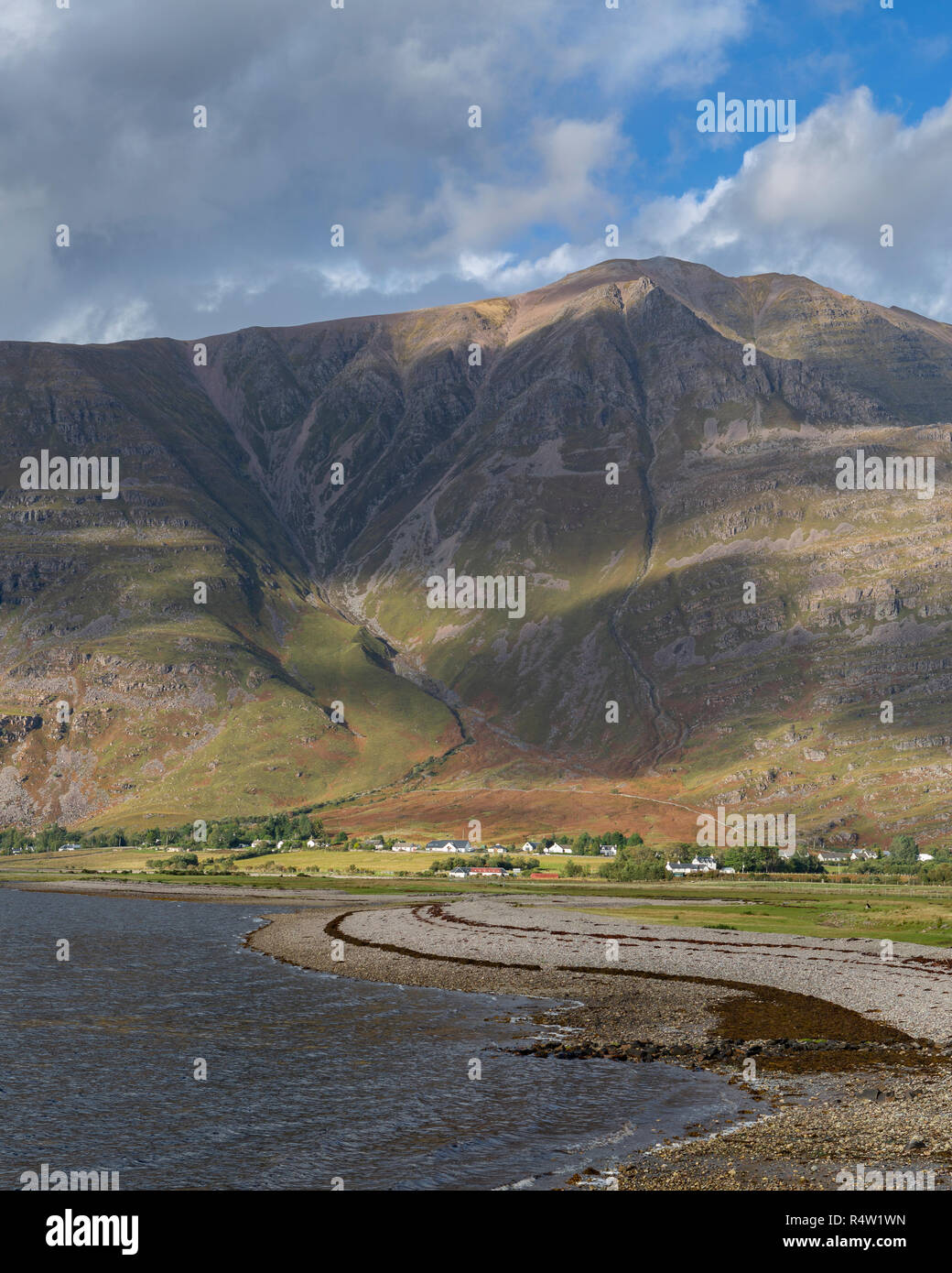 The size and scale of the mountain Liathach is shown by the village of ...