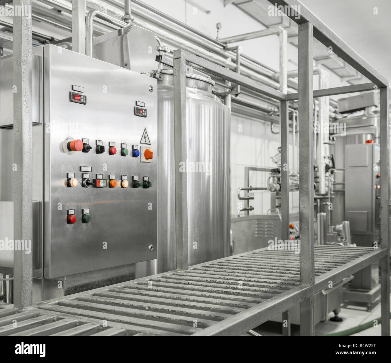 electronic control panel and tank at a milk factory. equipment at the ...
