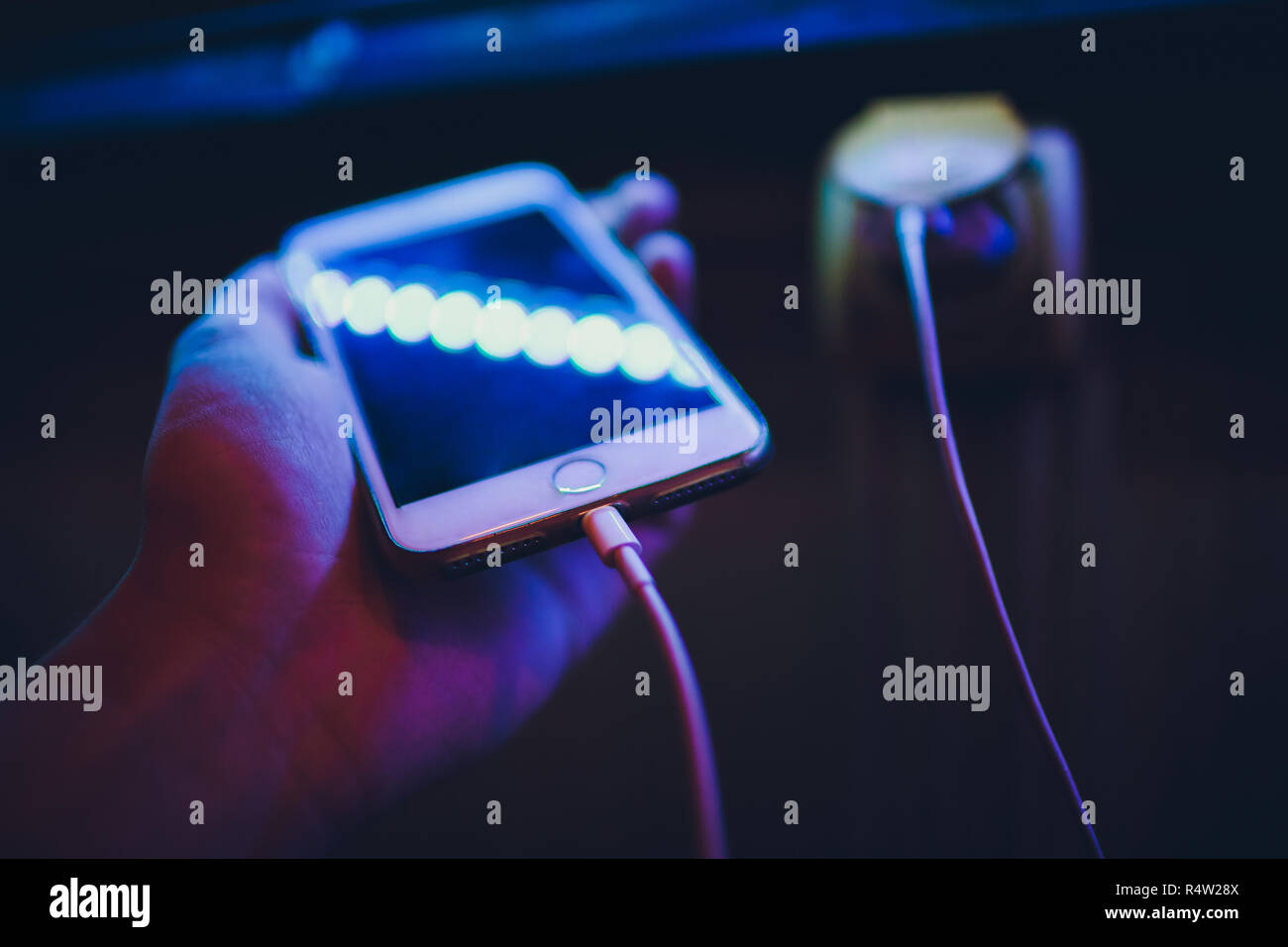 Hands of woman charging smartphone mobile phone device with cable and ...