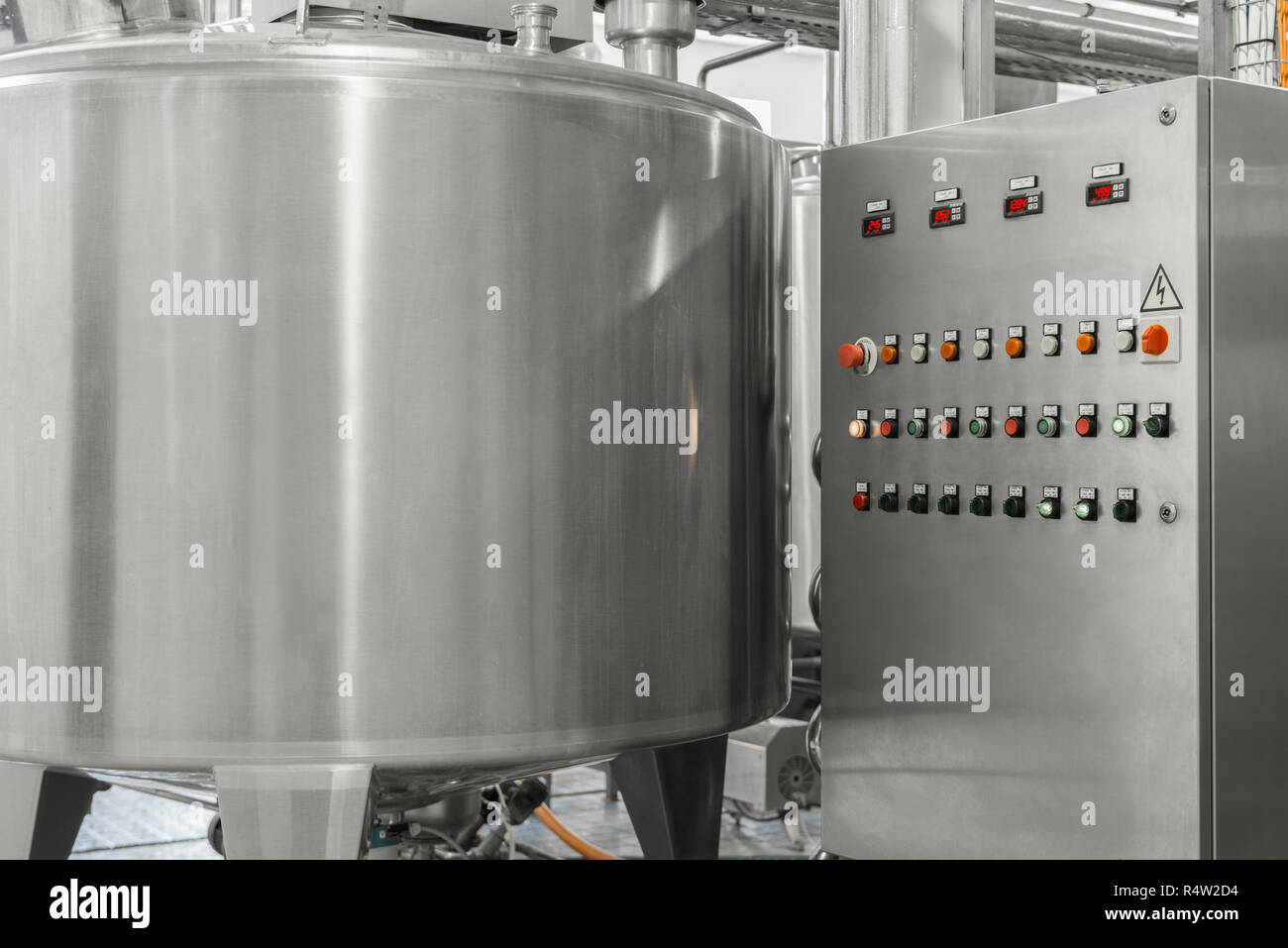 electronic control panel and tank at a milk factory. equipment at the ...