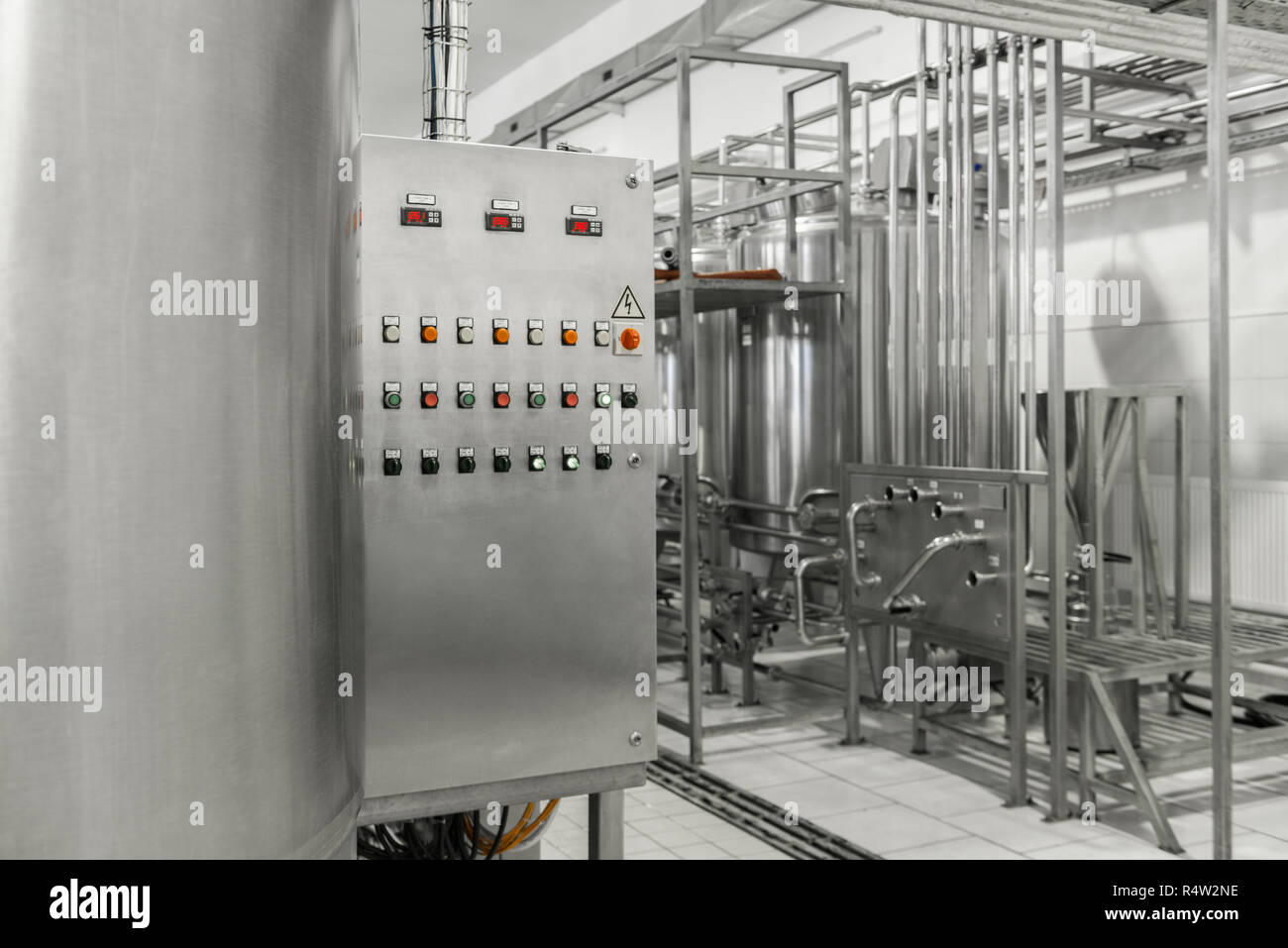 electronic control panel and tank at a milk factory. equipment at the ...