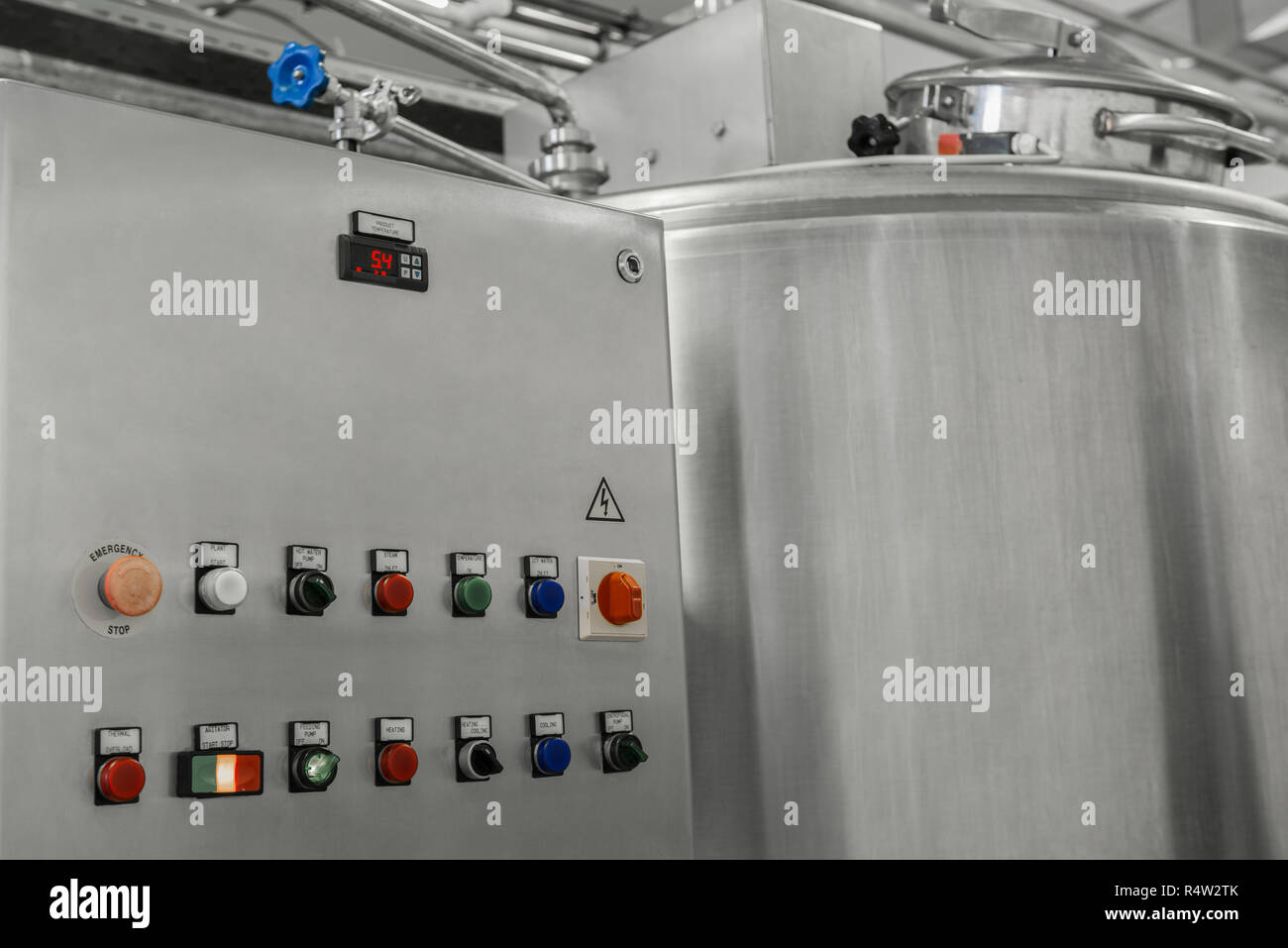 electronic control panel and tank at a milk factory. equipment at the ...