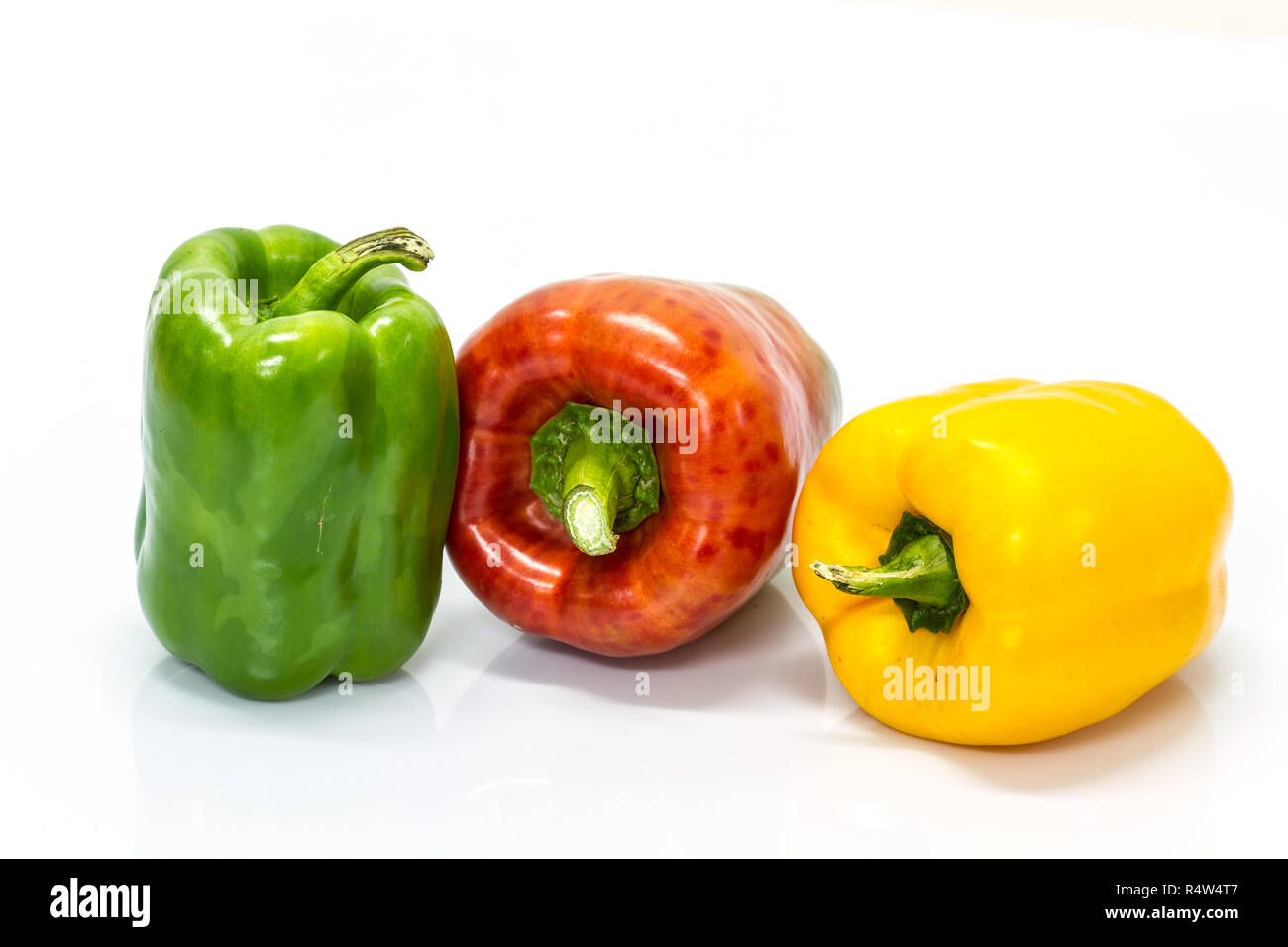 colored peppers over white background Stock Photo - Alamy