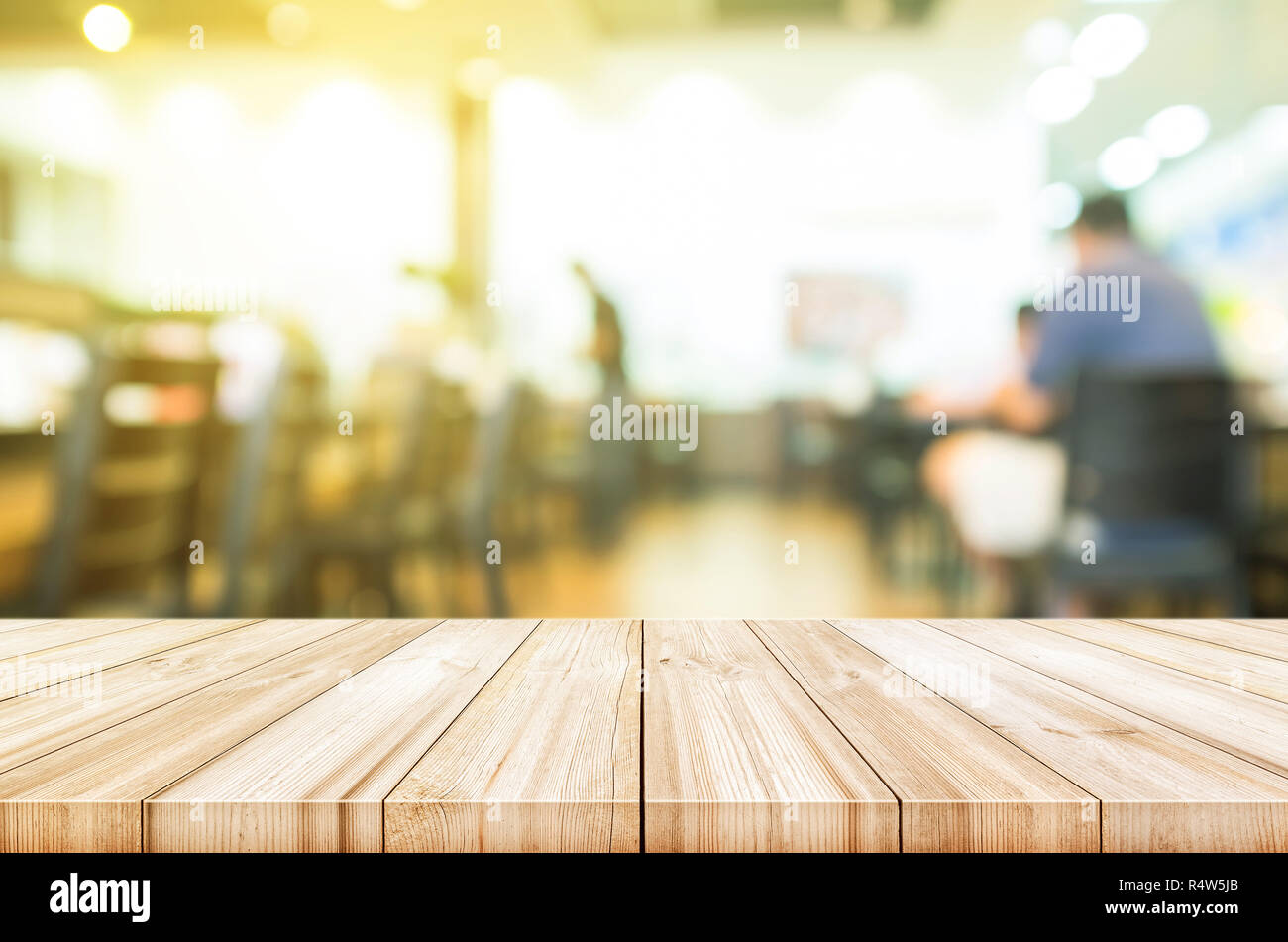 Empty wooden table top with blurred coffee shop interior background ...