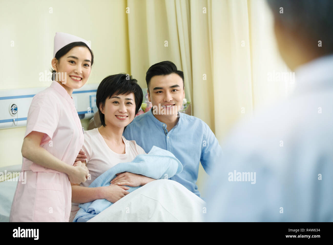 Medical staff and the parents of the newborn Stock Photo - Alamy