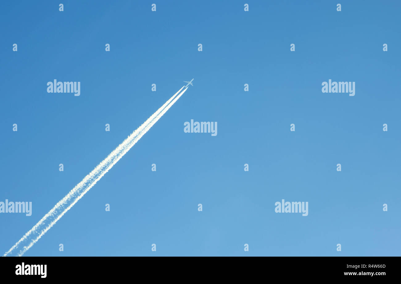 trace of an airplane against blue sky Stock Photo - Alamy