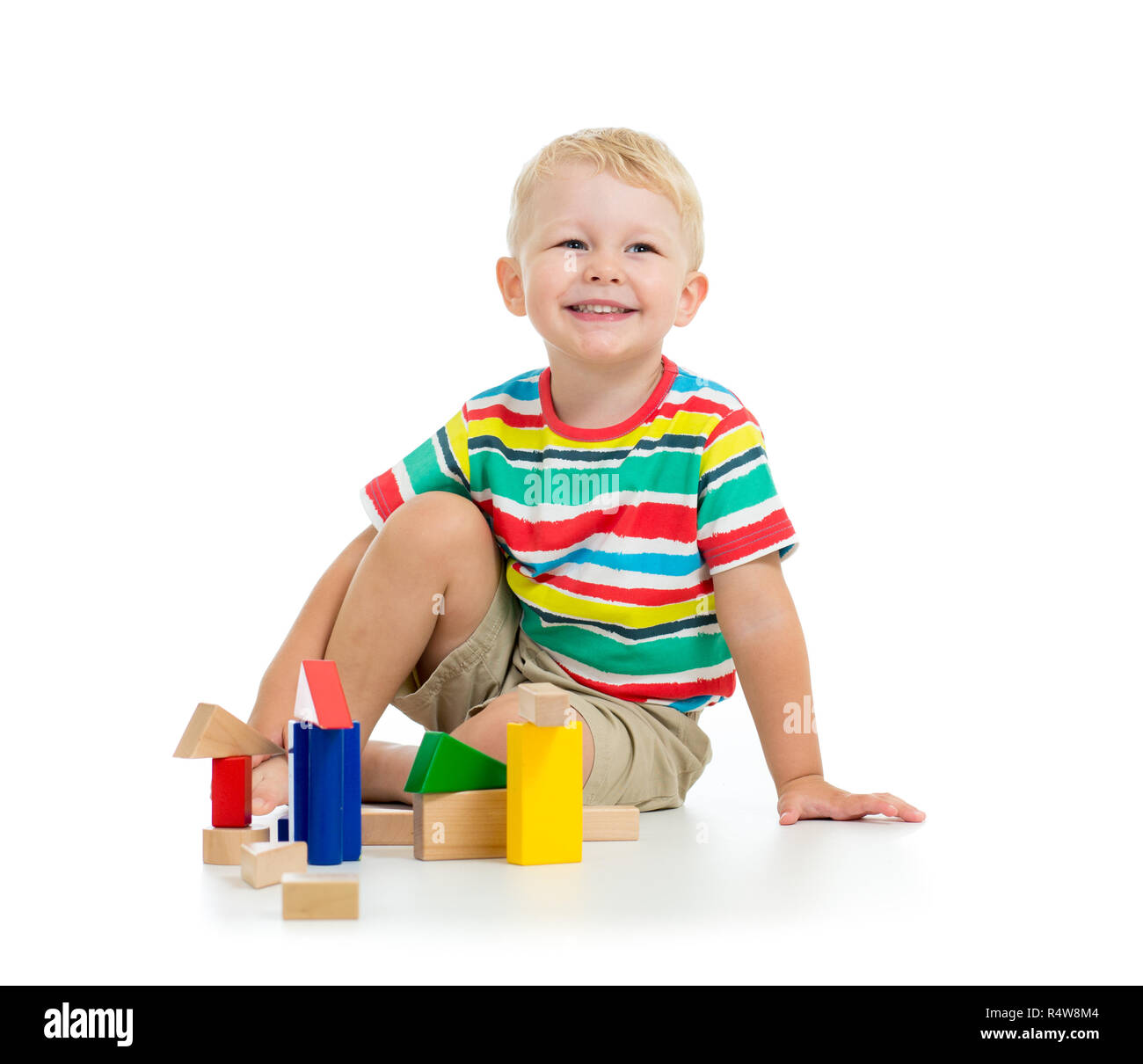 Handsome kid boy smiles and plays with colrful blocks, isolated Stock ...