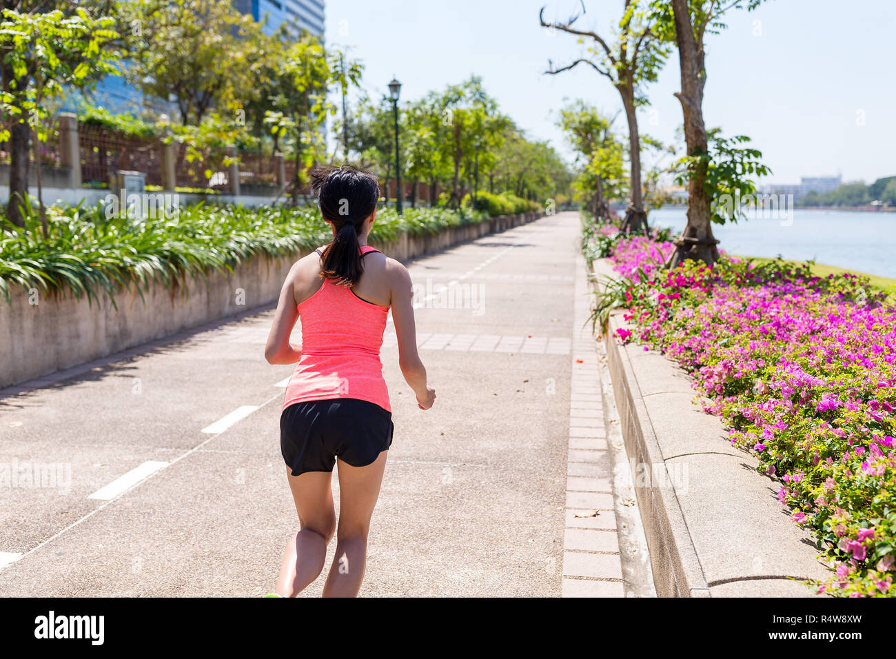 Back view of woman running in the park Stock Photo - Alamy