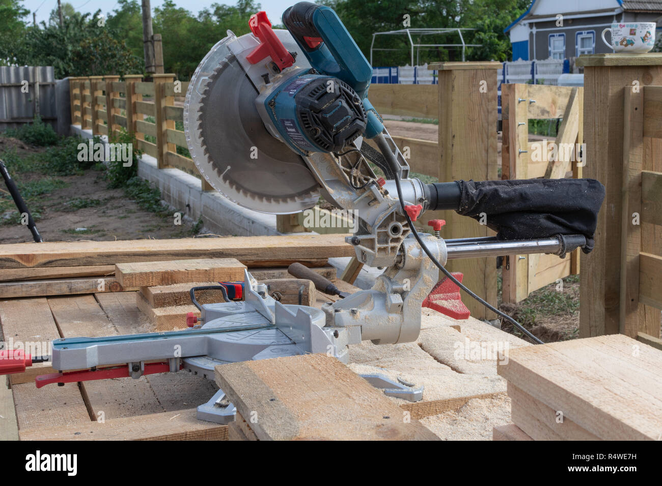 Man sawing a wood board with a circular saw Stock Photo - Alamy