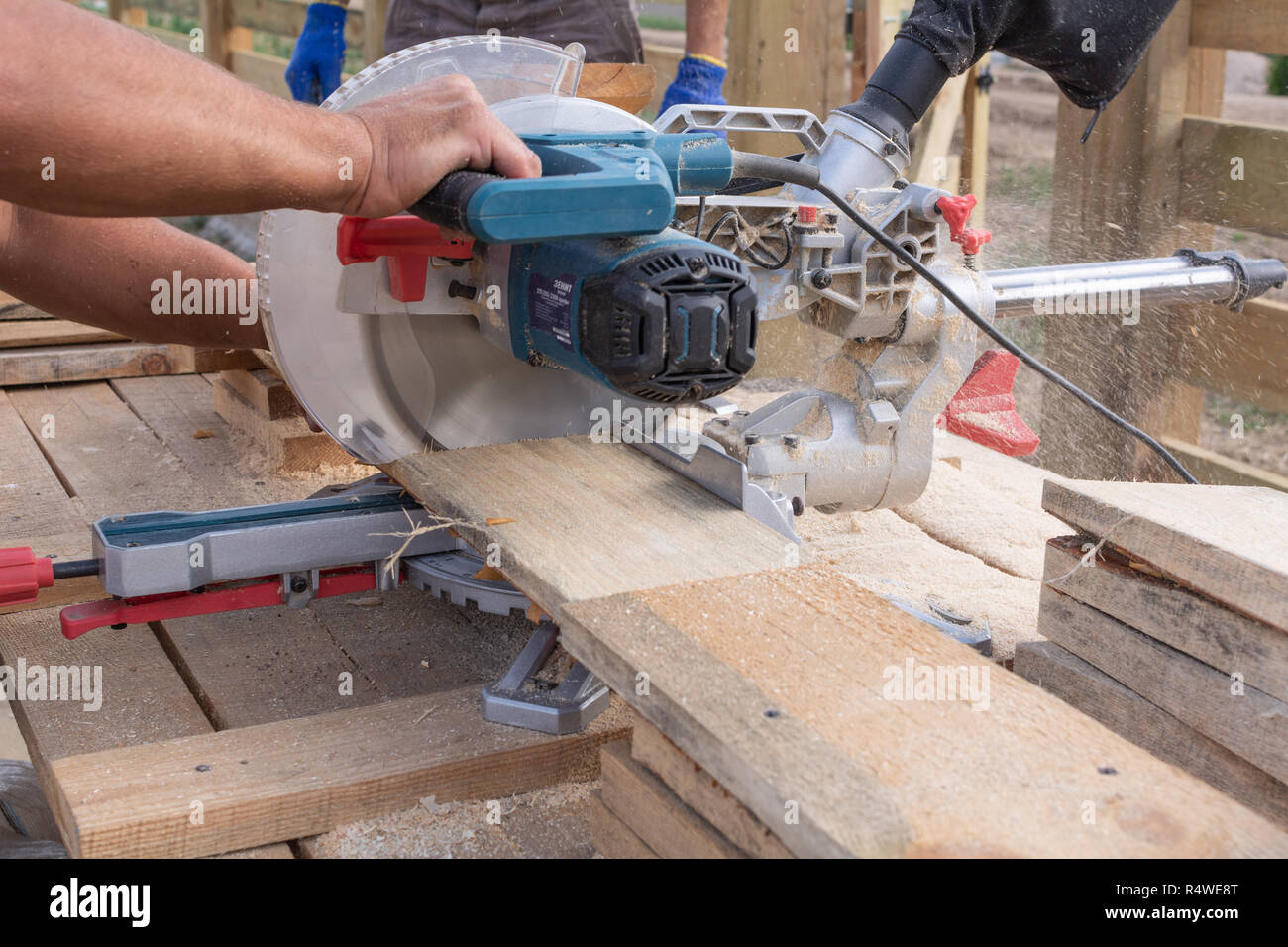 Man sawing a wood board with a circular saw Stock Photo - Alamy