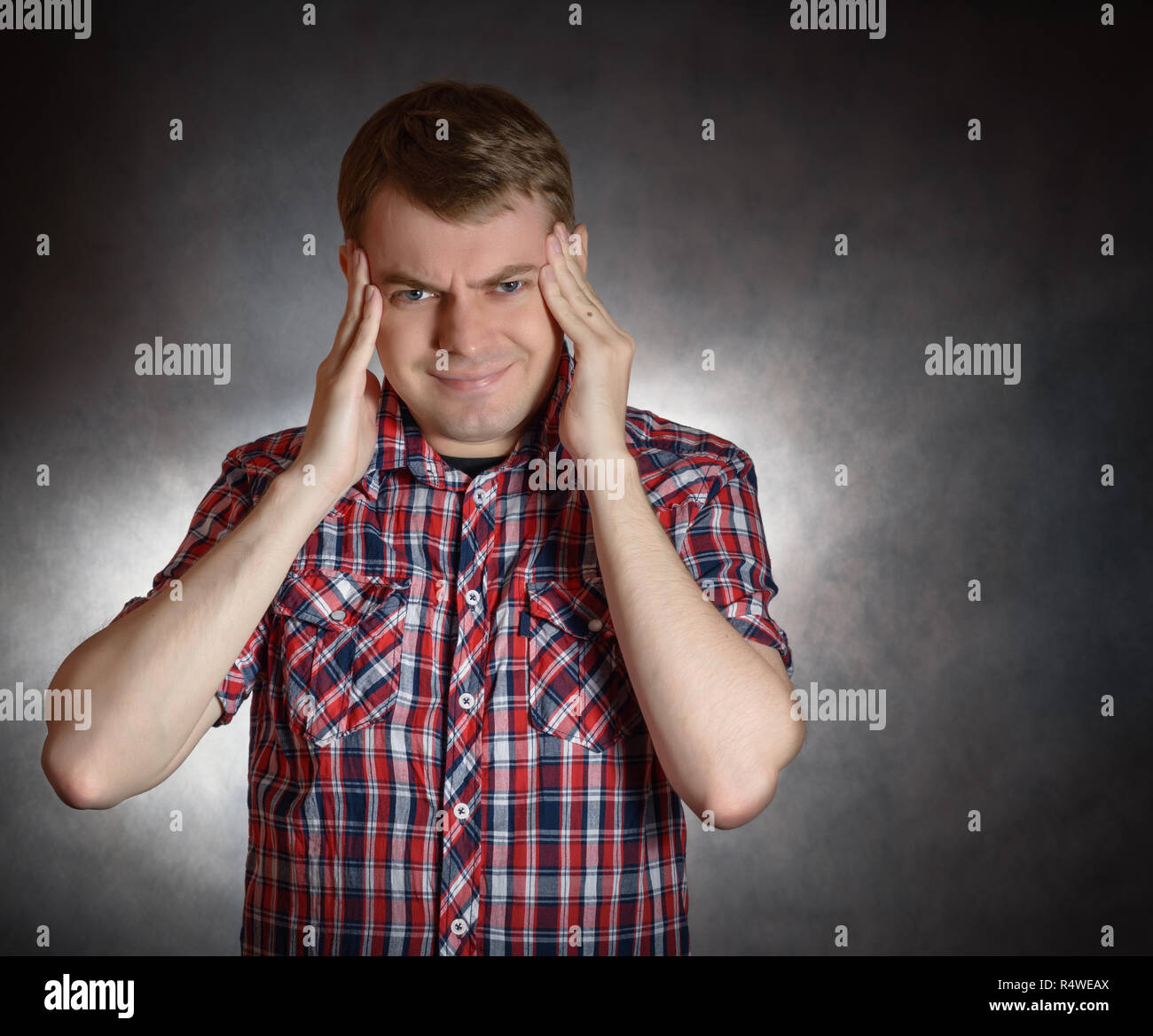 Portrait of young sad man suffering from headache Stock Photo - Alamy