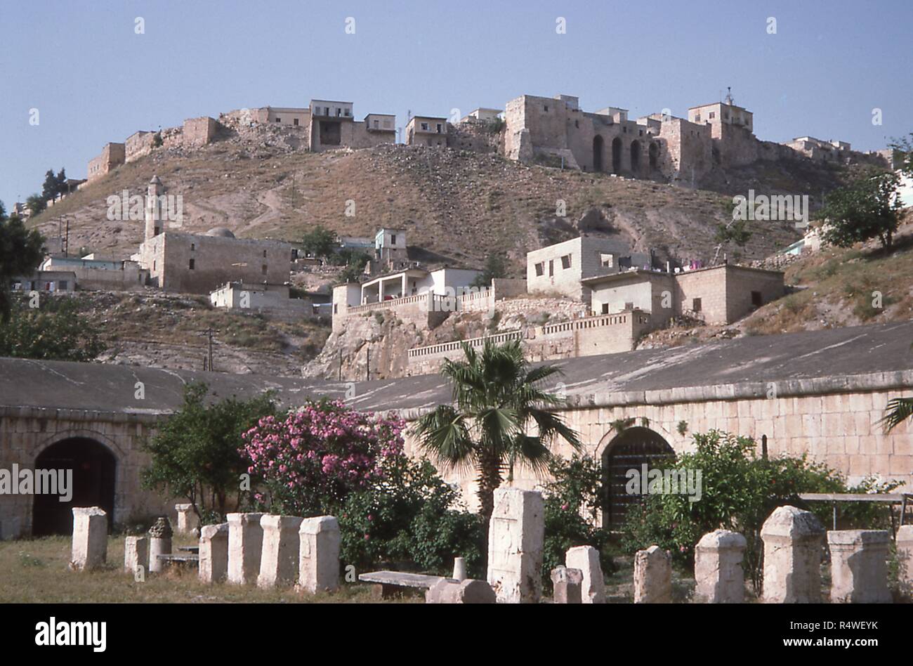 View of the hillside homes surrounding the medieval fortress of Qalaat ...