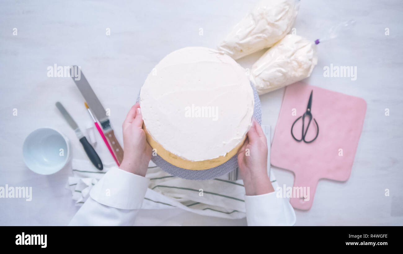 Flat lay. Frosting pink and purple cake with a white buttercream icing ...
