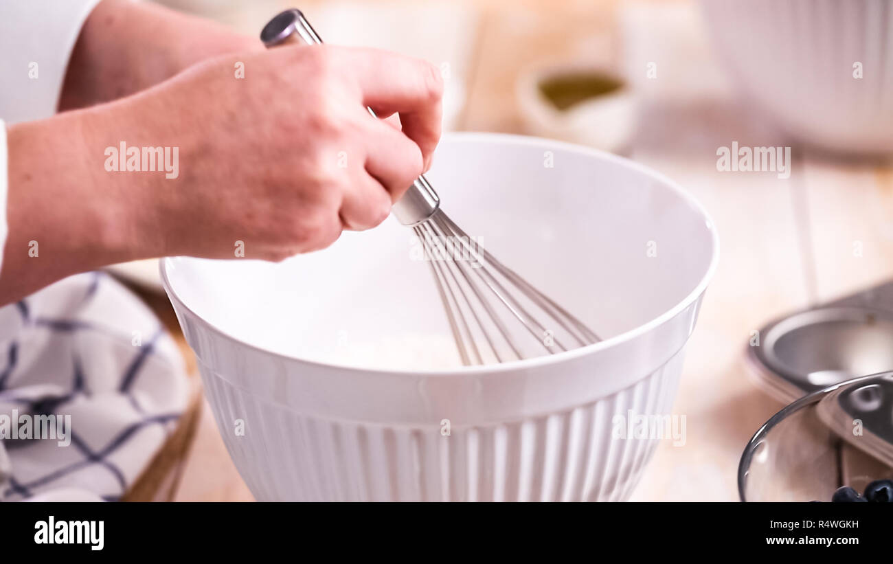 Mixing ingredients together in mixing bowl for blueberry muffins Stock ...