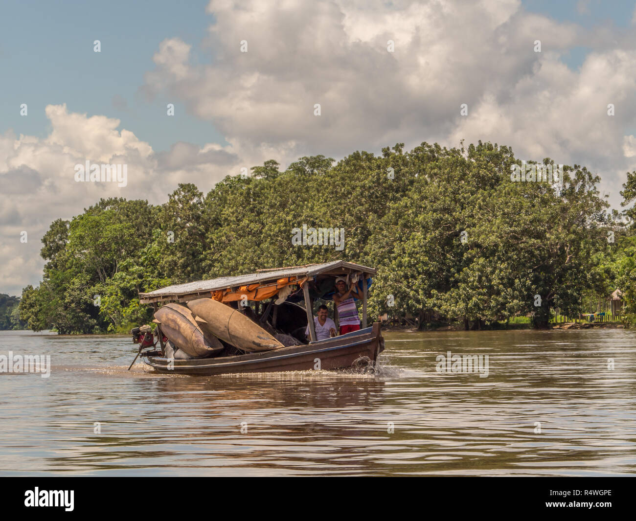 Amazon River, Brazil: - May 07, 2016: Small boat with locals on the ...