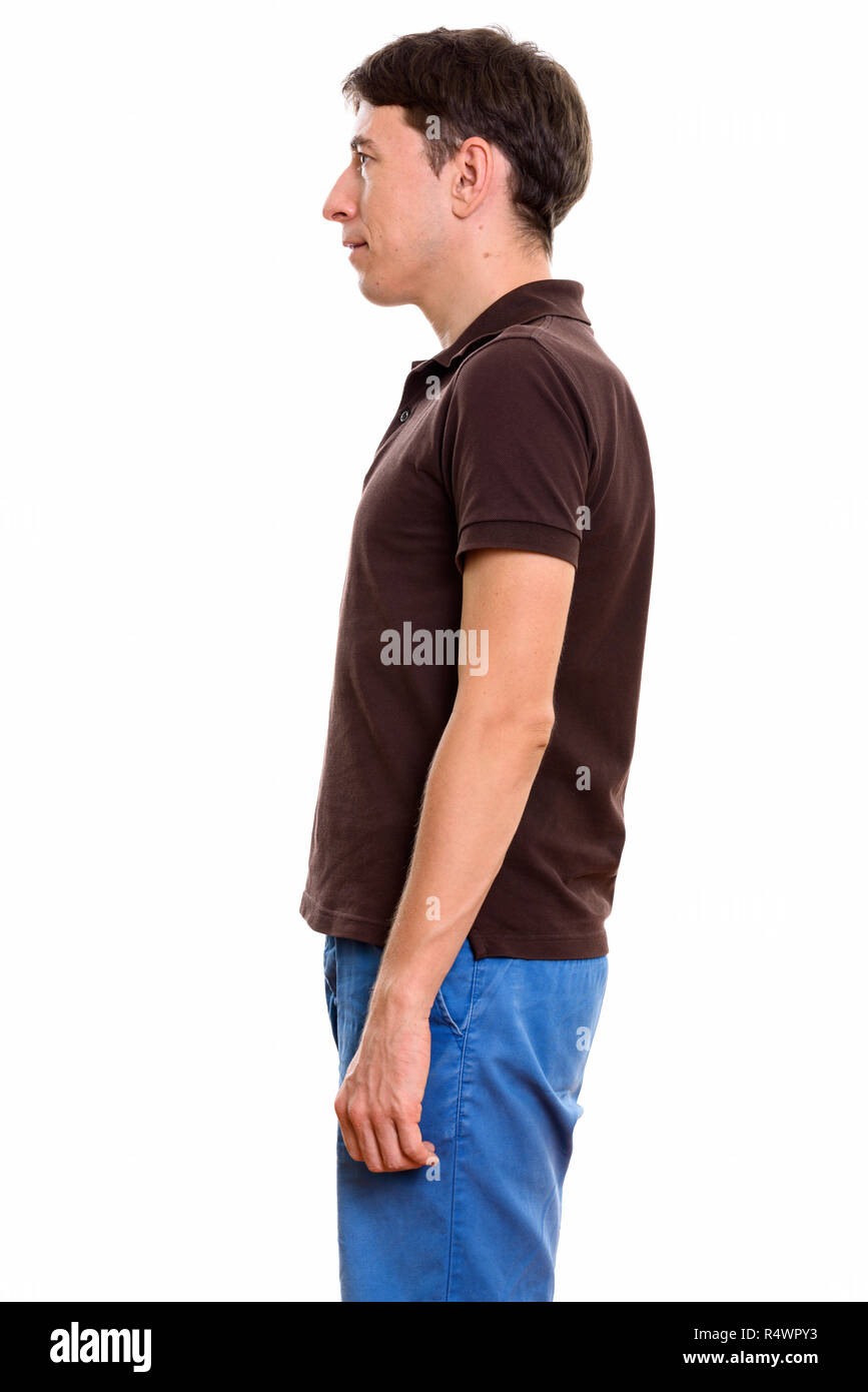 Profile view of man standing against white background Stock Photo - Alamy