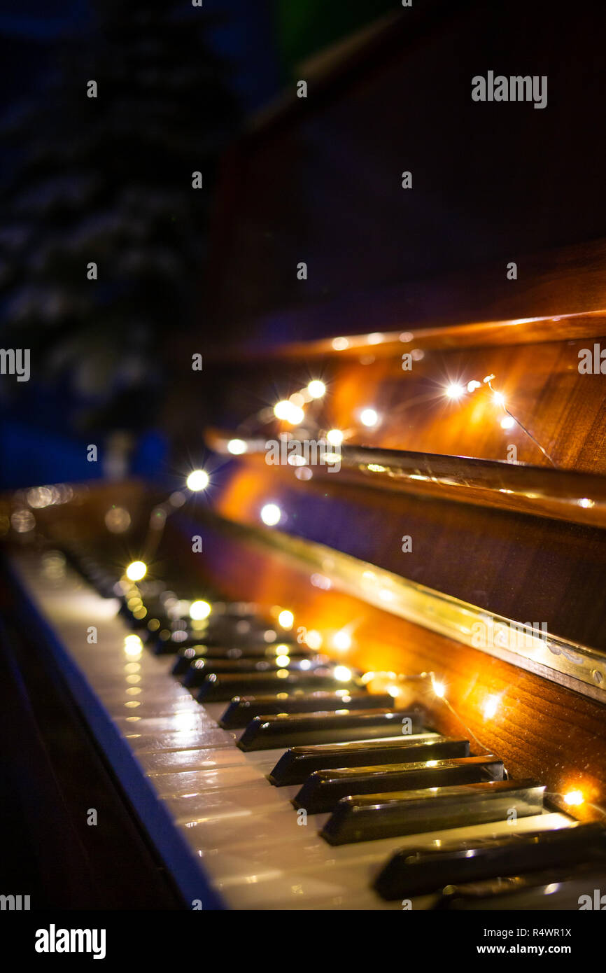 Piano keyboard illuminated with christmas lights. Romantic music ...