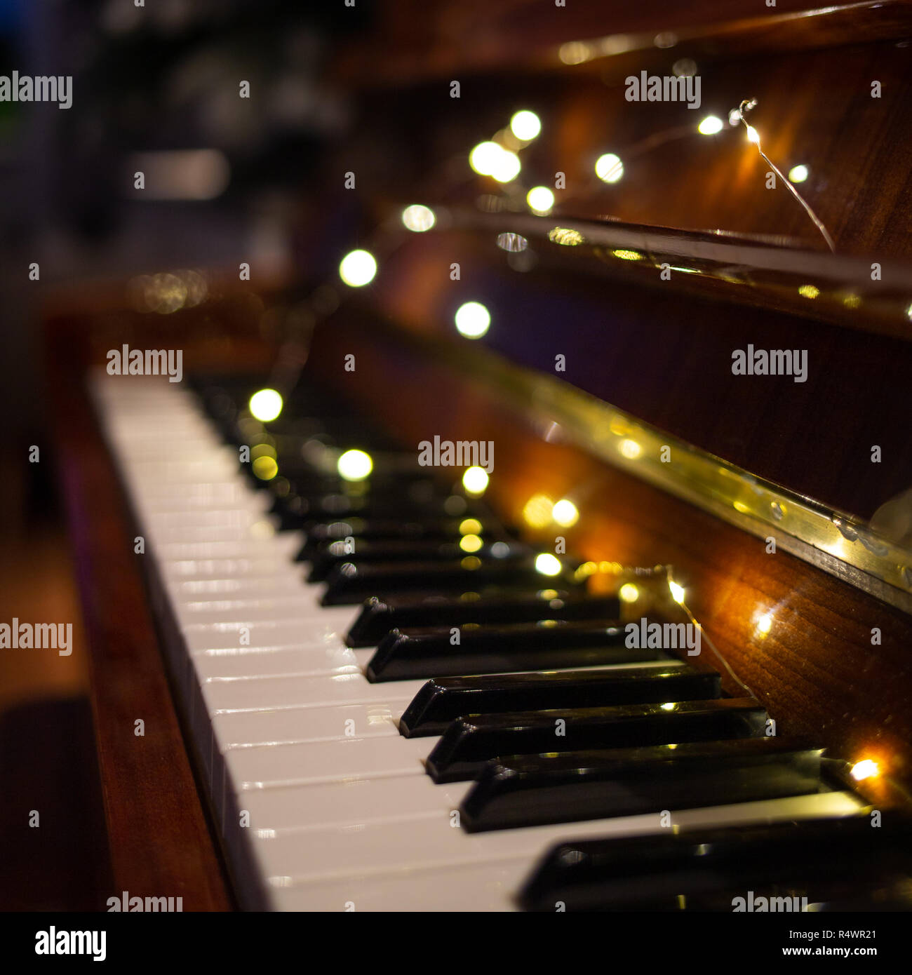 Piano keyboard illuminated with christmas lights. Romantic music ...