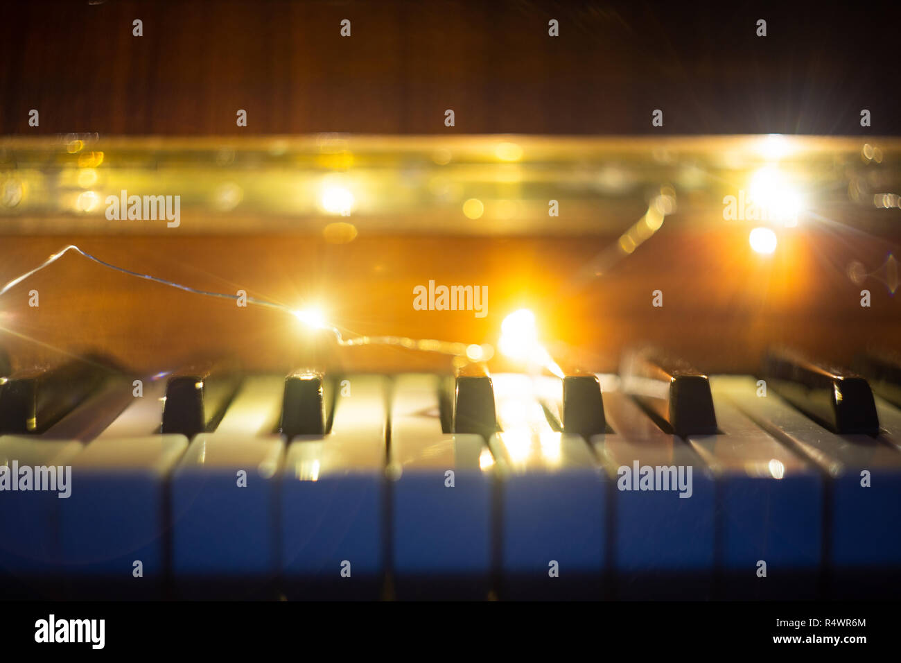 Front view of piano keyboard illuminated with christmas lights Stock ...