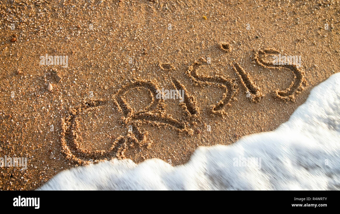 Conceptual photo of sea waves washing off word crisis written on the ...