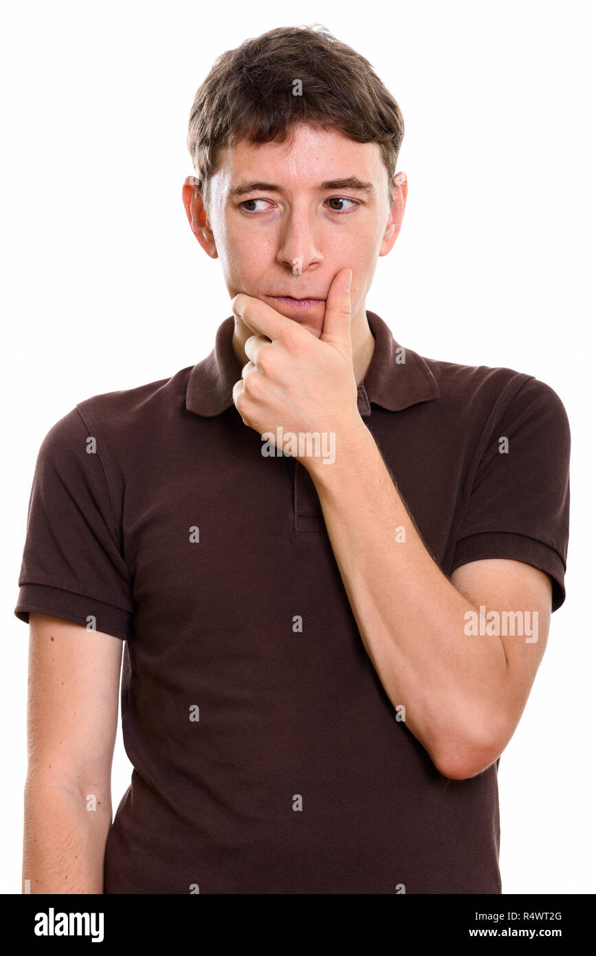 Studio shot of man thinking while looking down Stock Photo - Alamy
