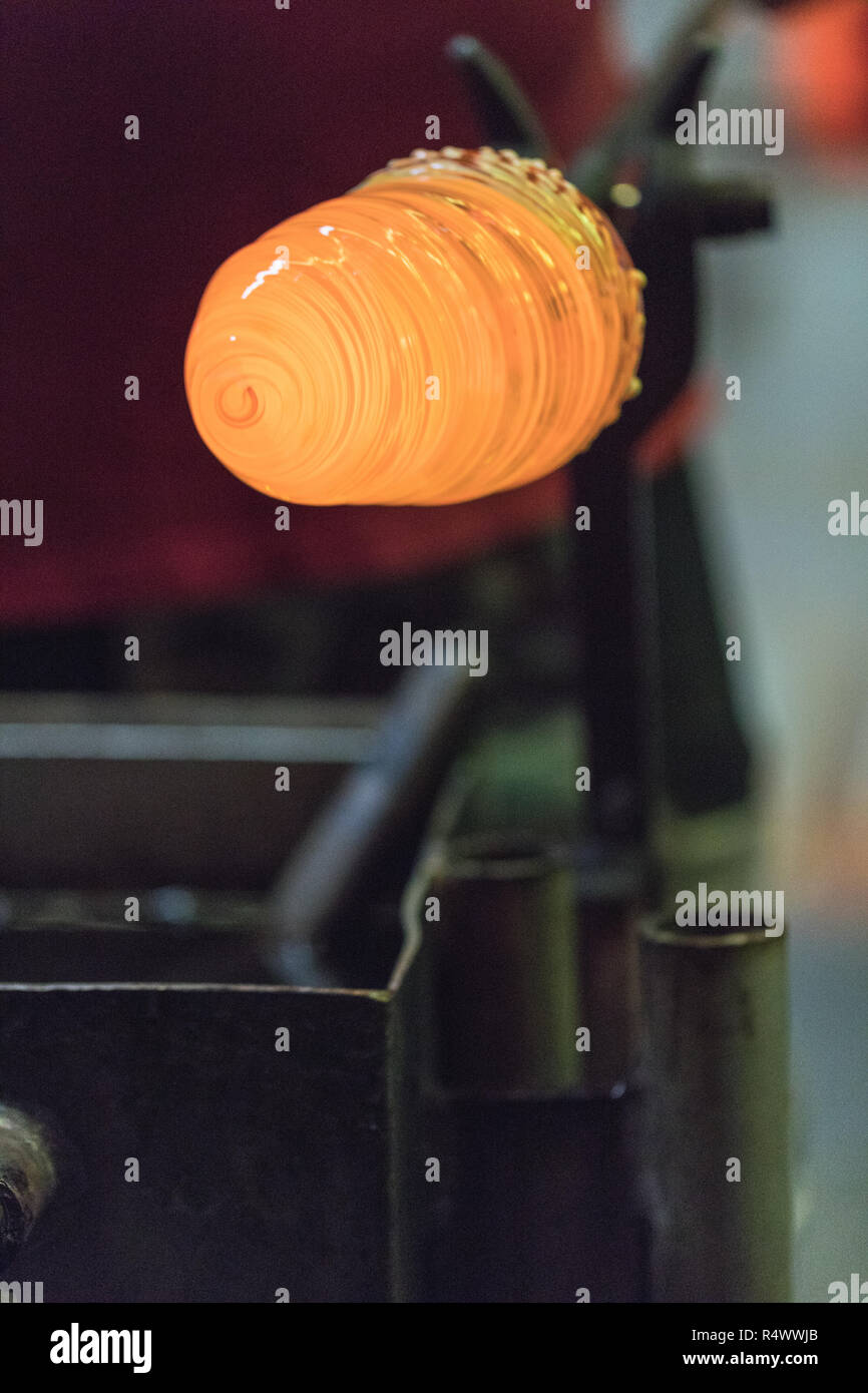 glass blower carefully forming hot glass to a decorative vase, germany ...