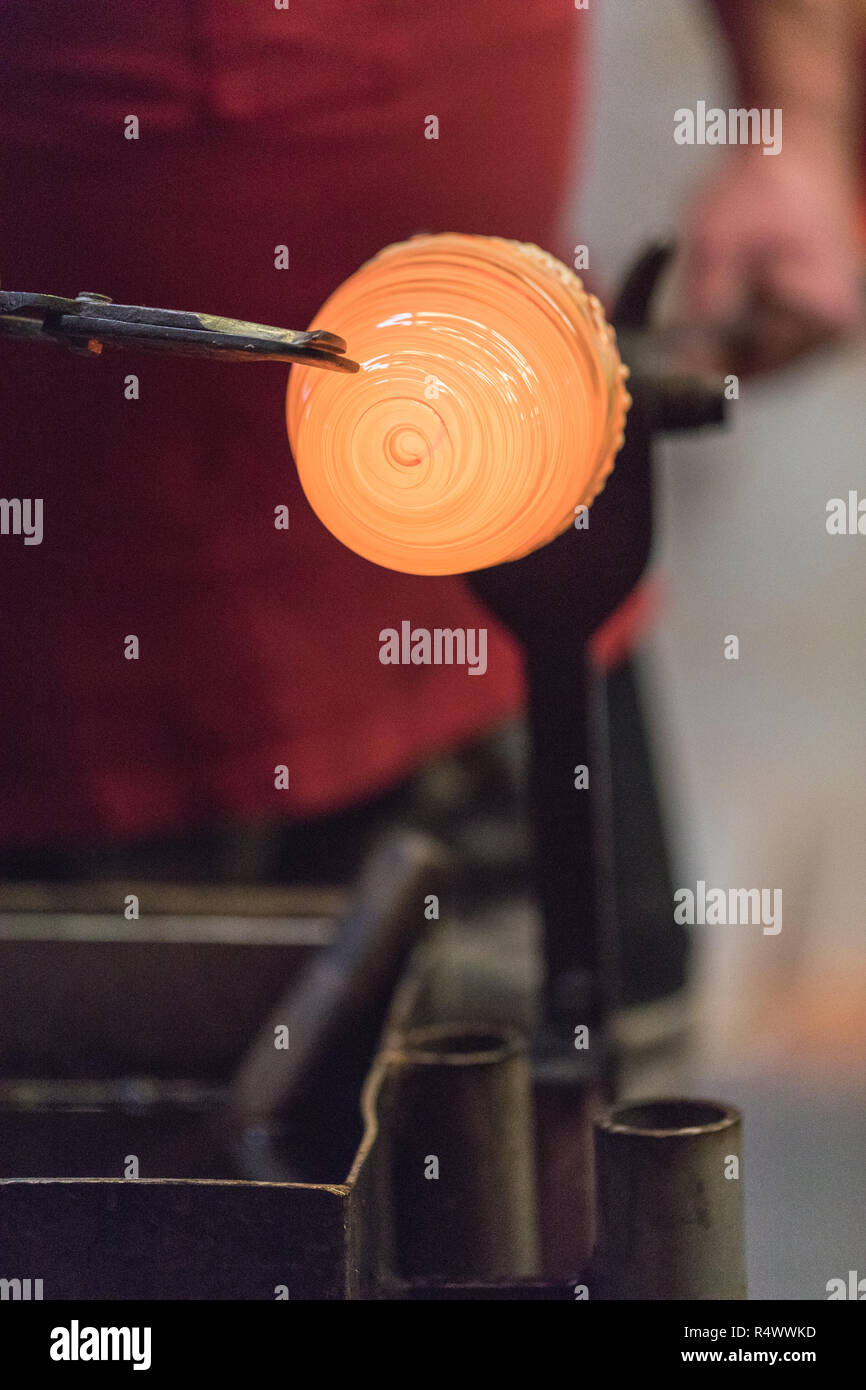 glass blower carefully forming hot glass to a decorative vase, germany ...
